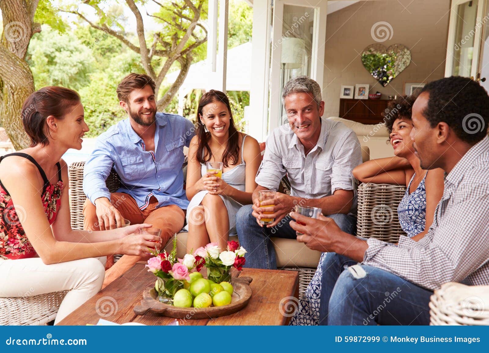 Group of Friends Socialising in a Conservatory Stock Image - Image of ...