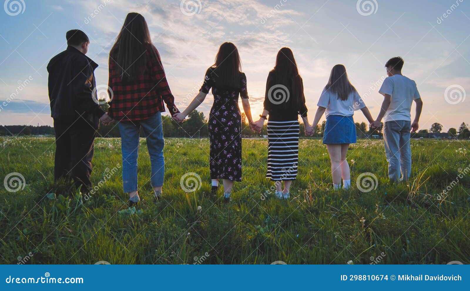 A Group of Friends Stand in a Row at Sunset. Stock Photo - Image of ...