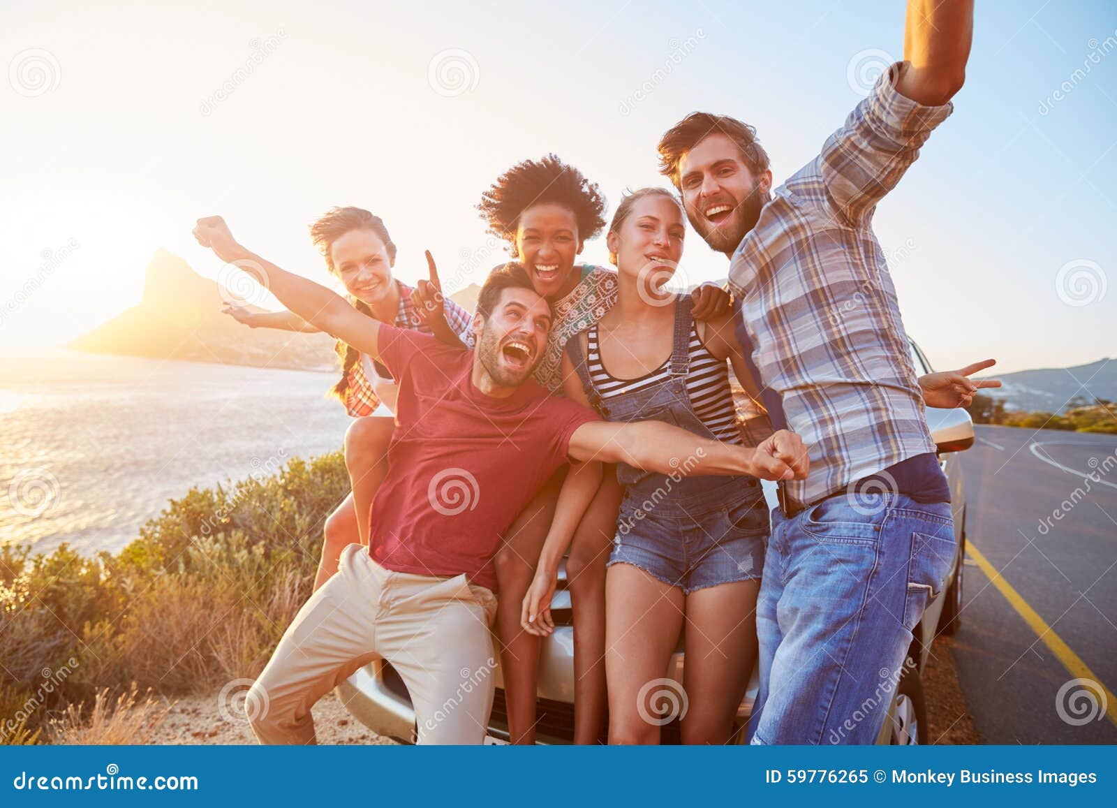 Group of Friends Standing by Car on Coastal Road at Sunset Stock Image ...