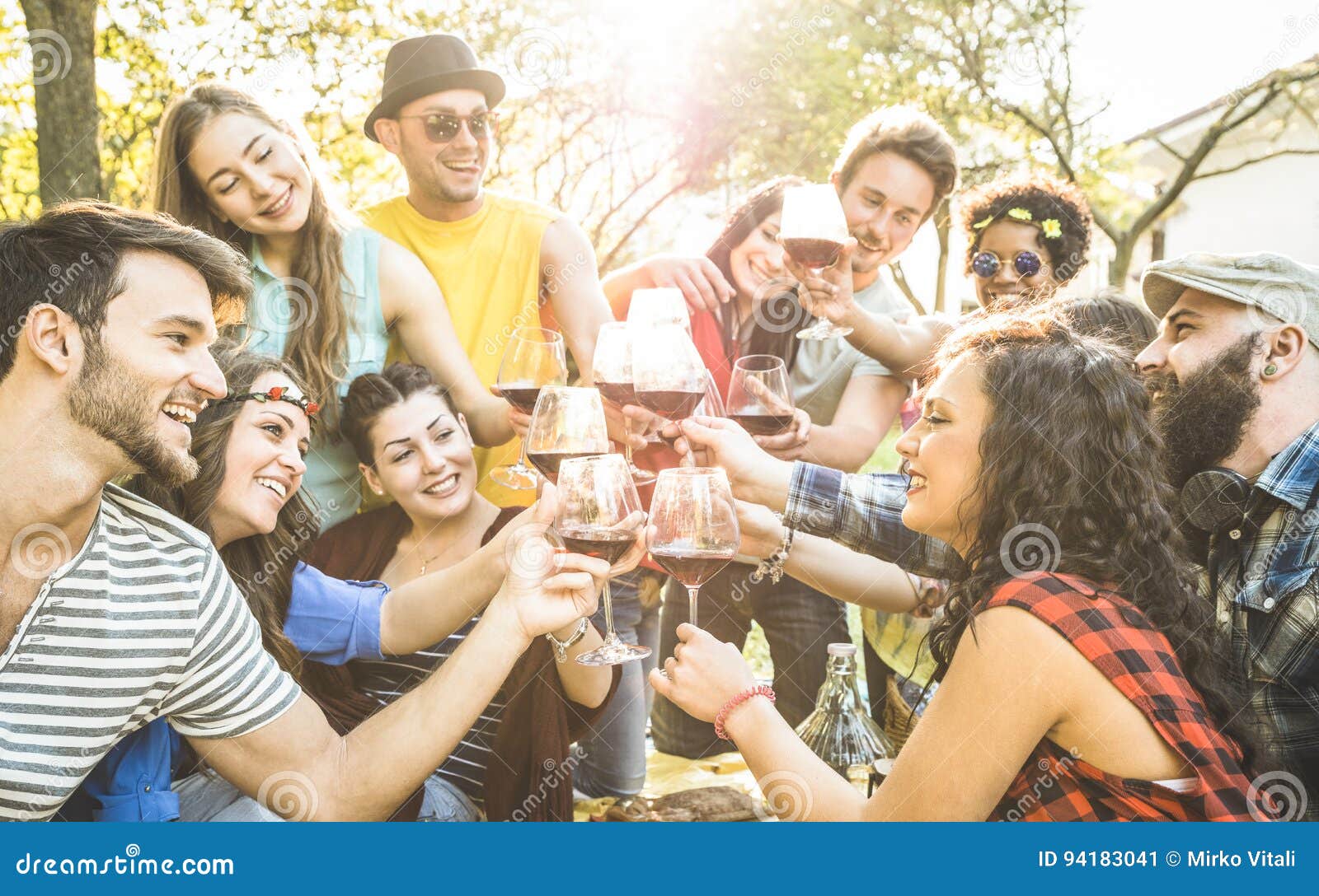 Group Of Friends Toasting Wine Having Fun At Barbecue Garden Party
