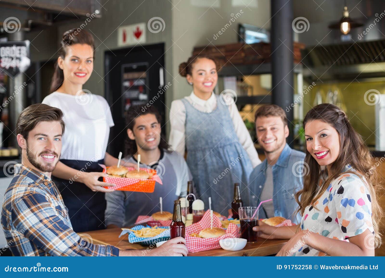 Group of Friends with Waitress in Restaurant Stock Photo - Image of ...