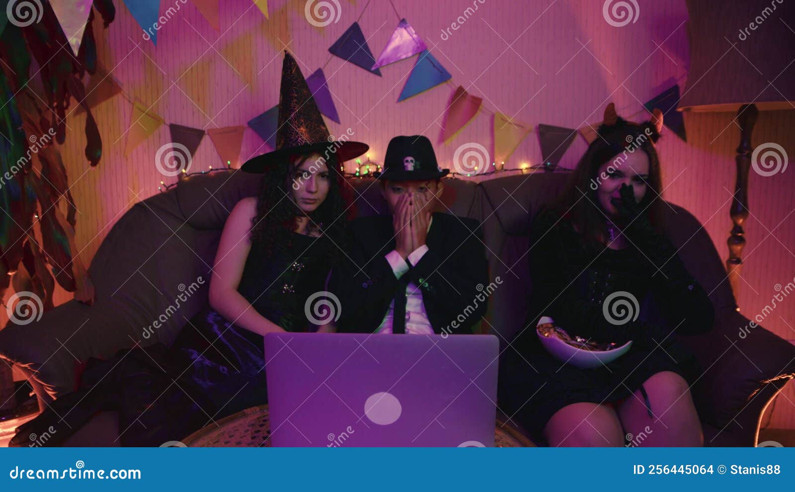 A Group of Friends is Watching a Movie on a Computer about Halloween ...