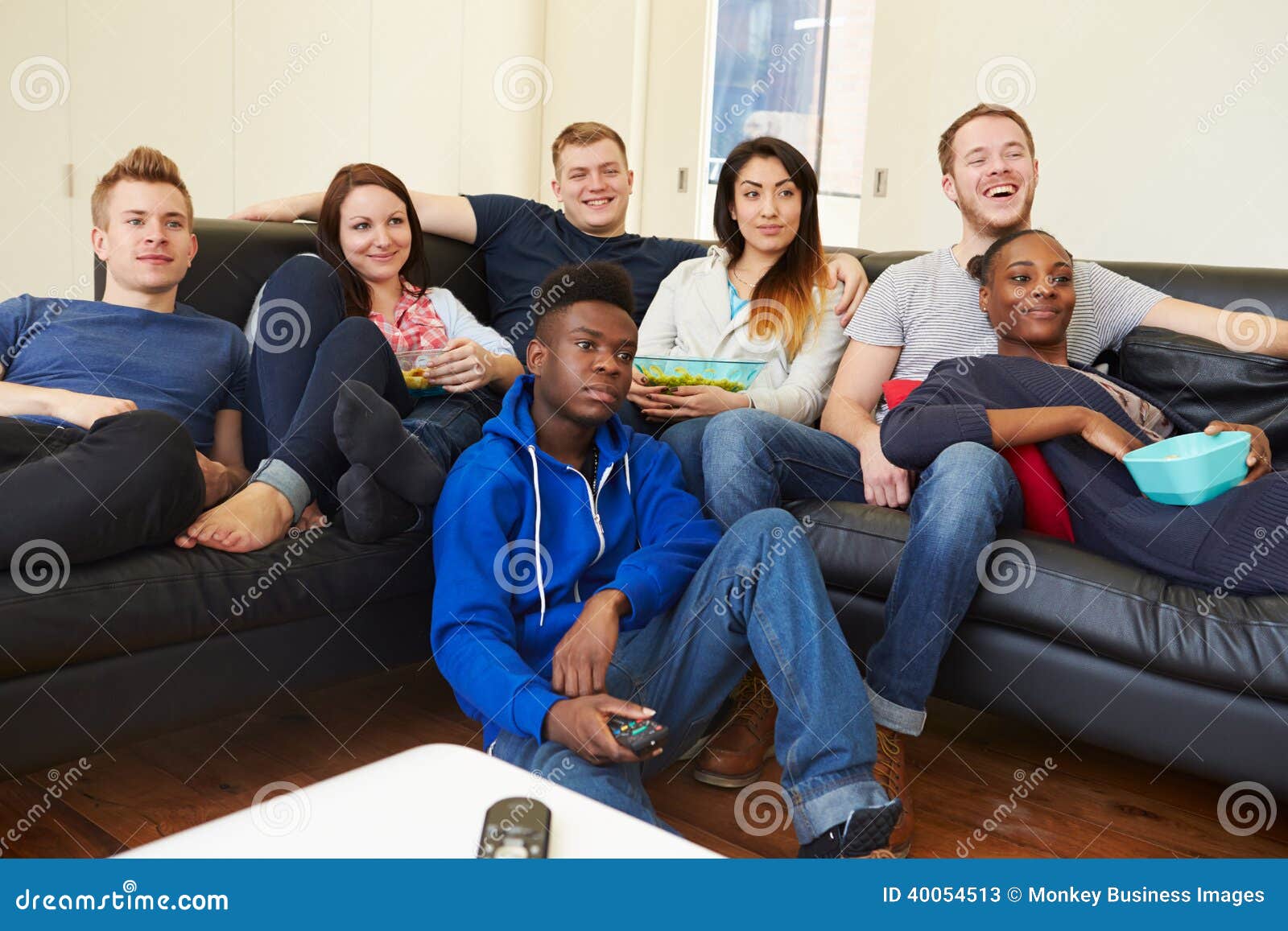 Group of Friends Watching Television at Home Together Stock Image ...