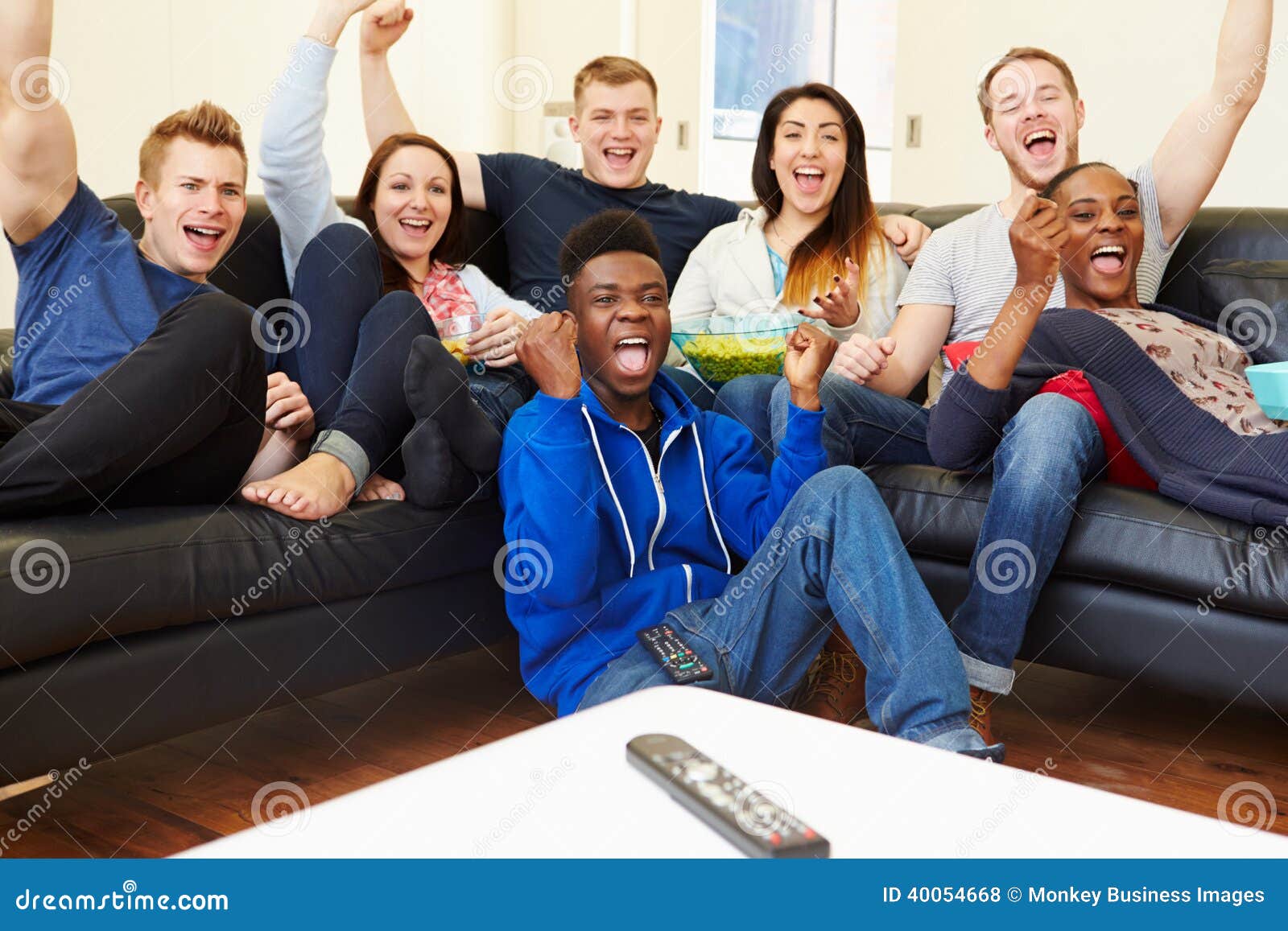 Group of Friends Watching Television at Home Together Stock Photo ...