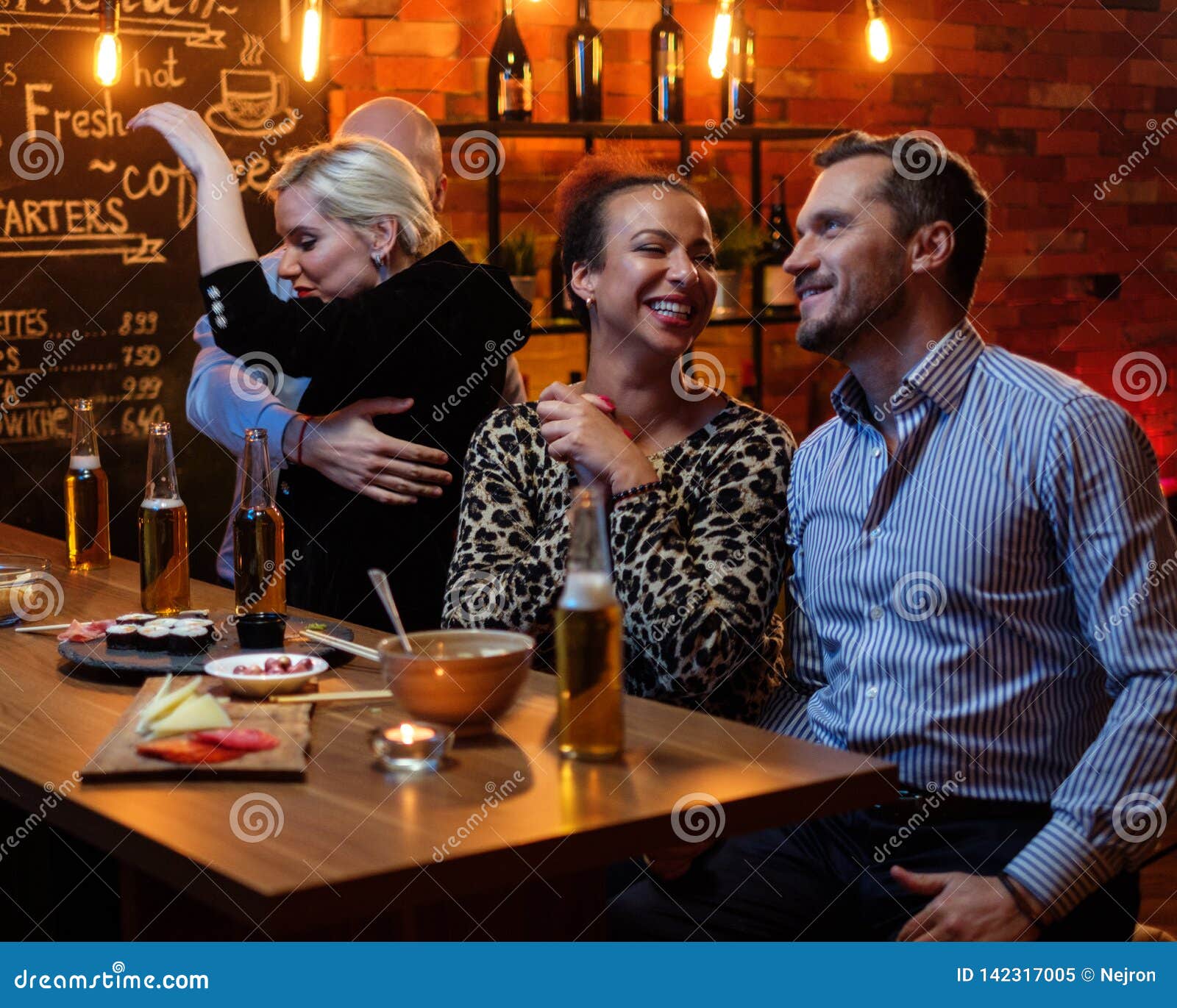 Group of Friends Watching Tv in a Cafe Behind Bar Counter Stock Image ...
