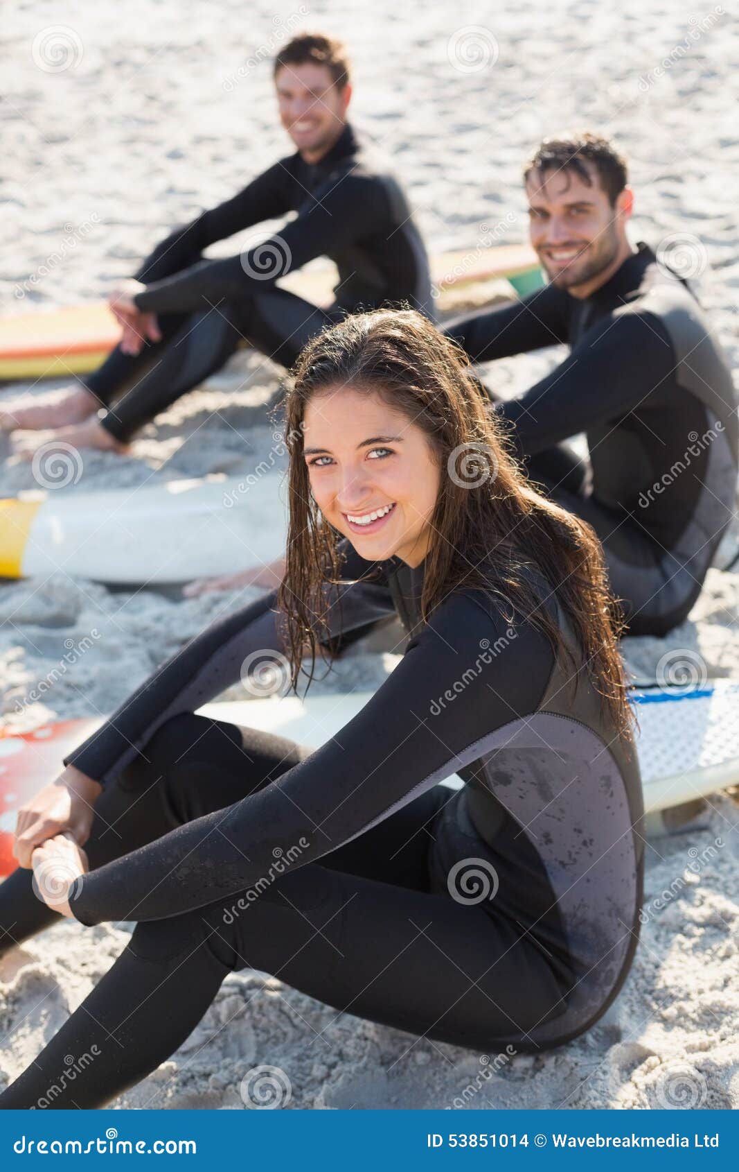 Group of Friends on Wetsuits with a Surfboard on a Sunny Day Stock ...