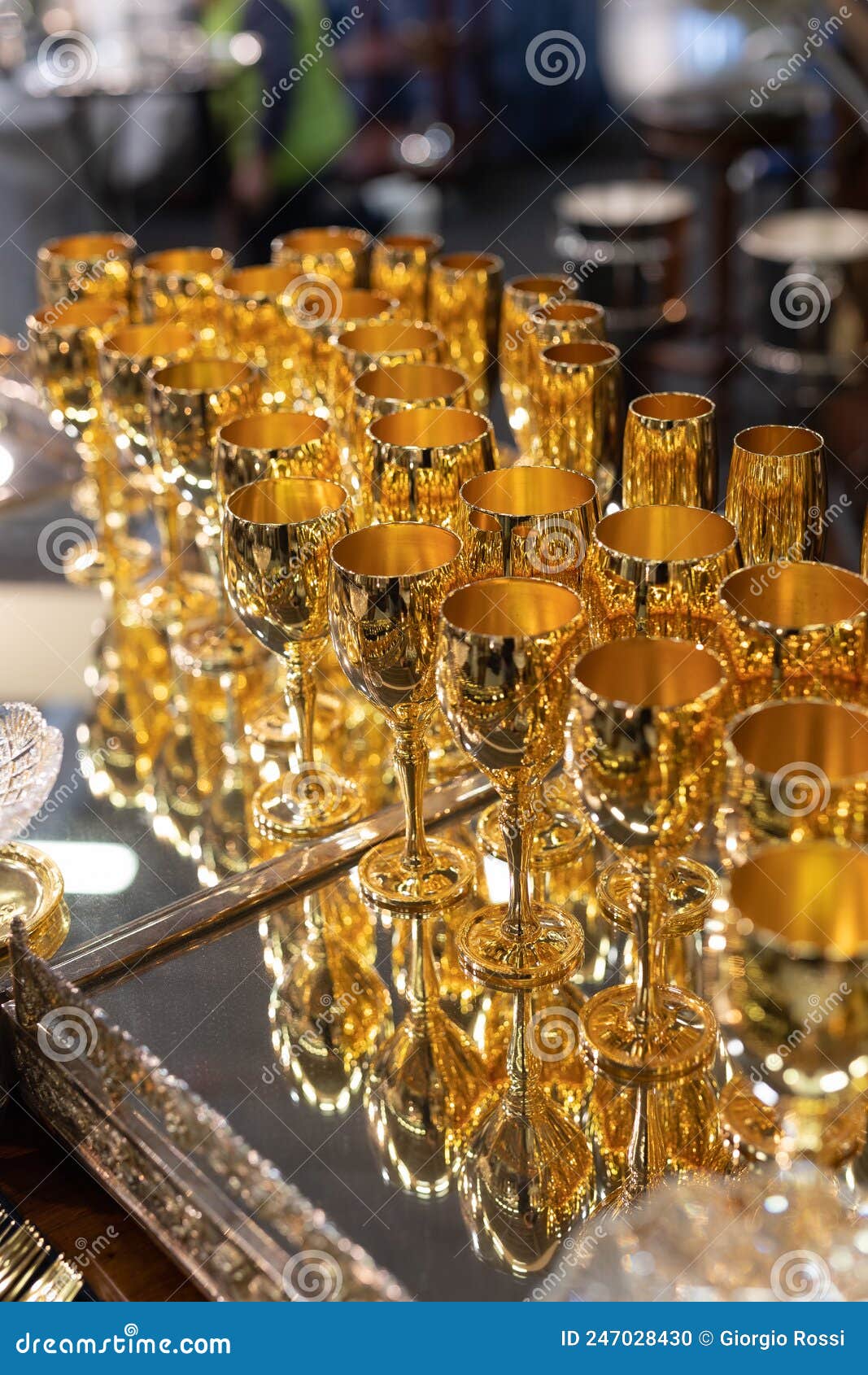 Group of Gilded Goblets Arranged Neatly on a Mirrored Tray with ...