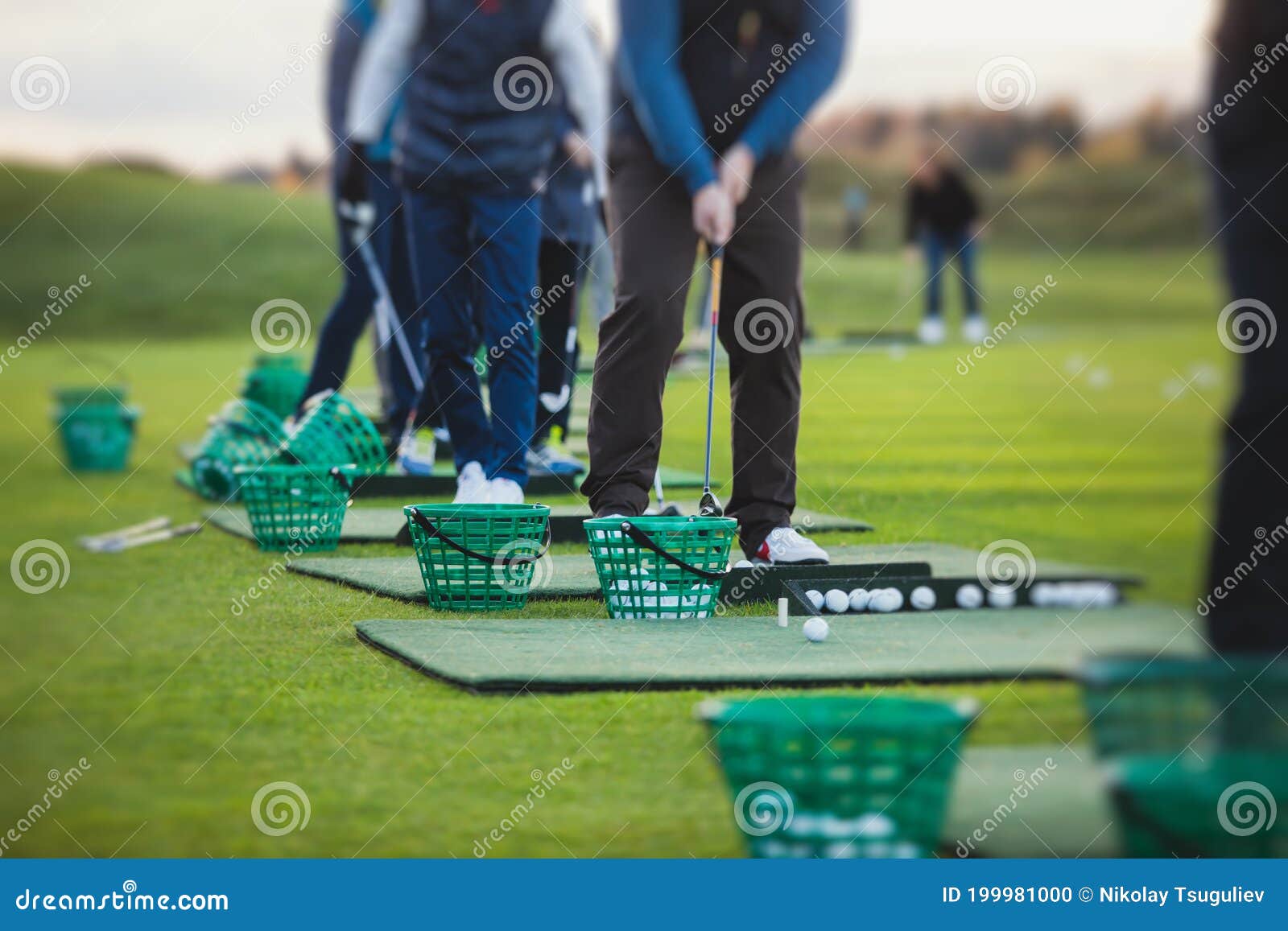 Group of Golfers Practicing and Training Golf Swing on Driving Range ...