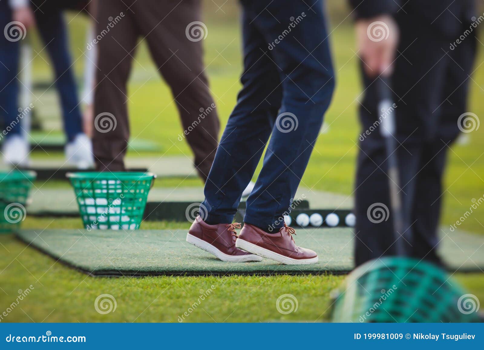 Group Of Golfers Practicing And Training Golf Swing On Driving Range ...