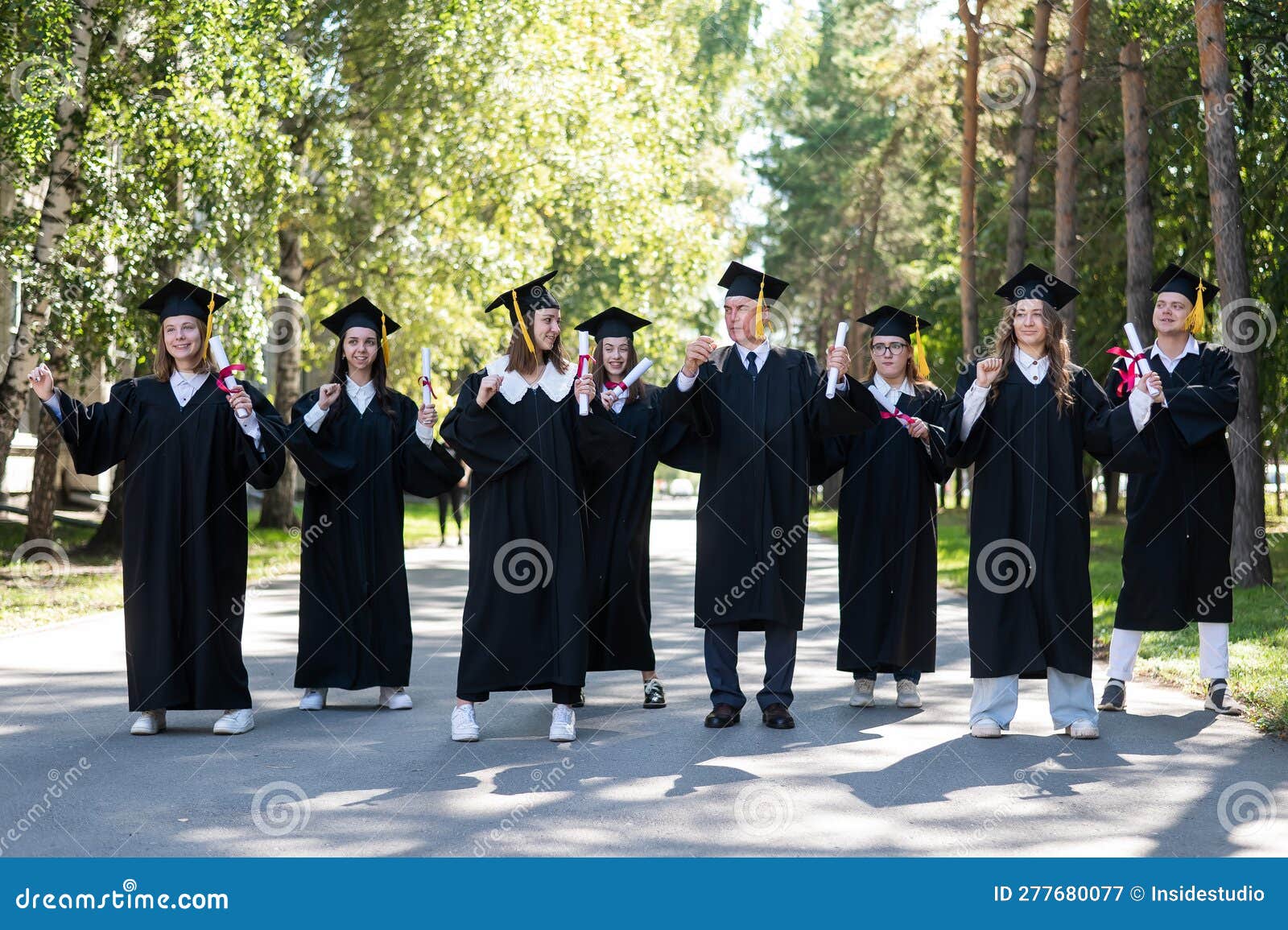 Group of Graduates in Robes Dancing Outdoors. Elderly Student. Stock ...
