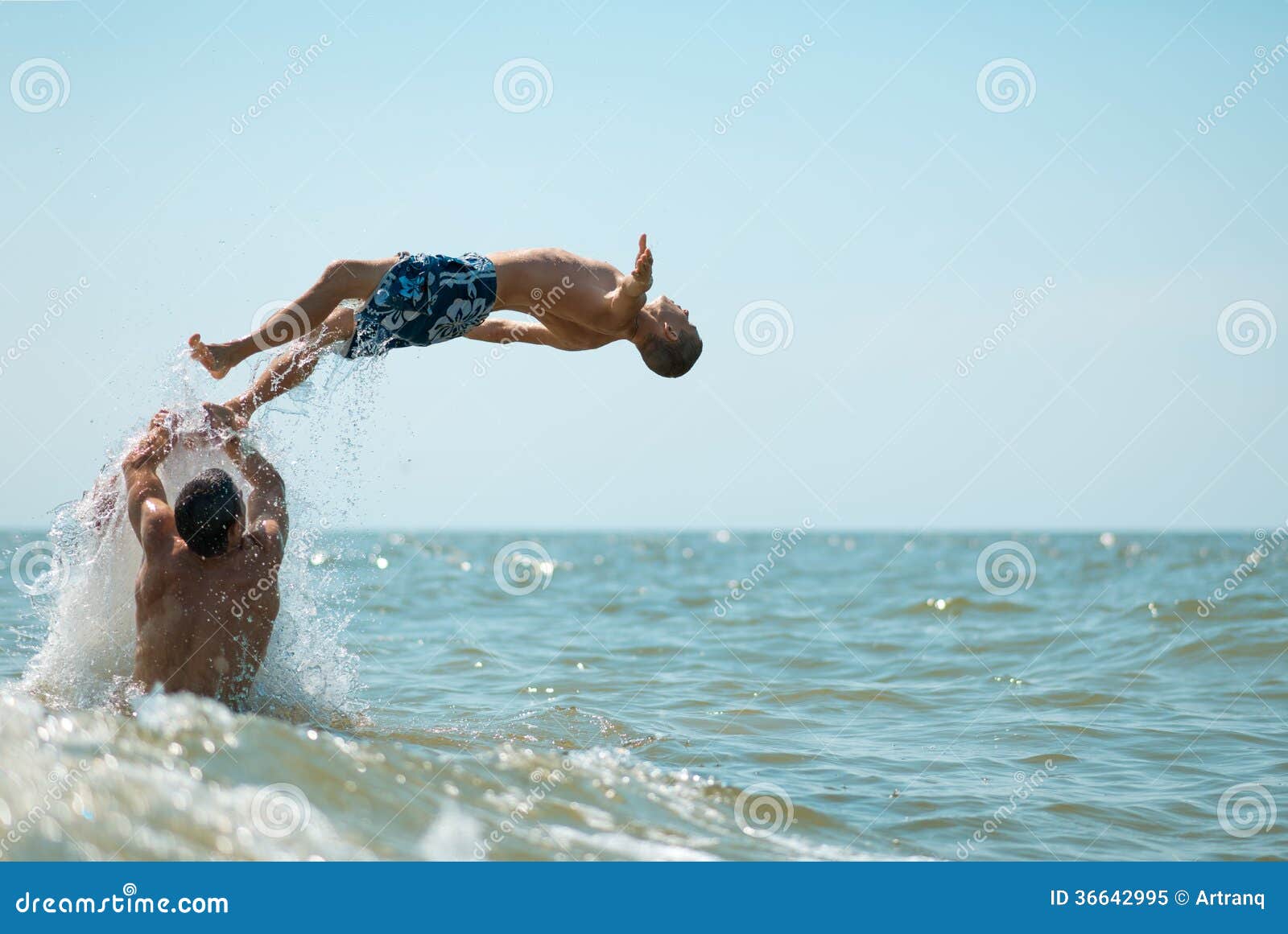 Group of Guys Standing in the Sea Tossed Up Man Stock Image - Image of ...
