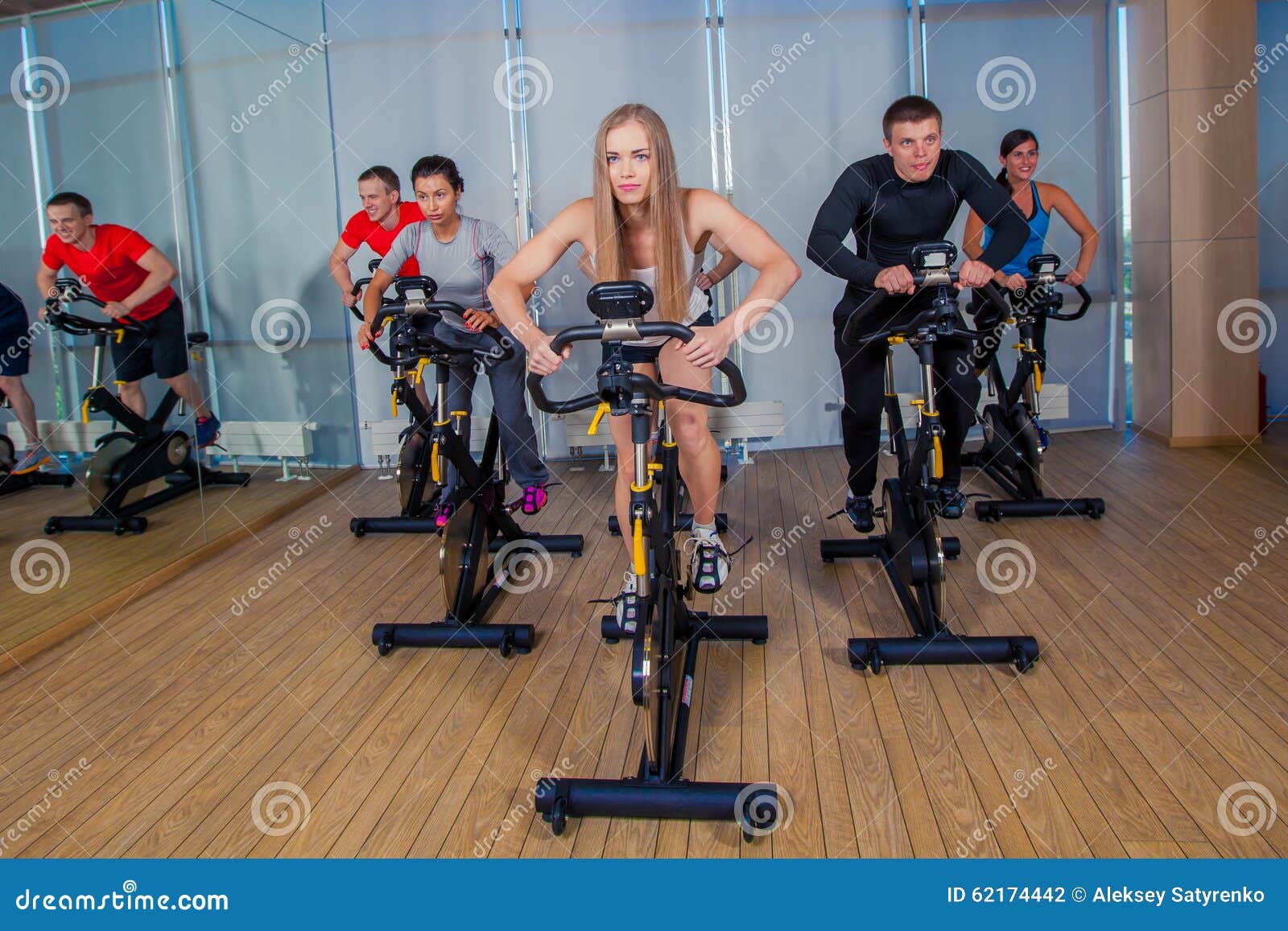 Group of Gym People on Machines Stock Photo - Image of beautiful ...