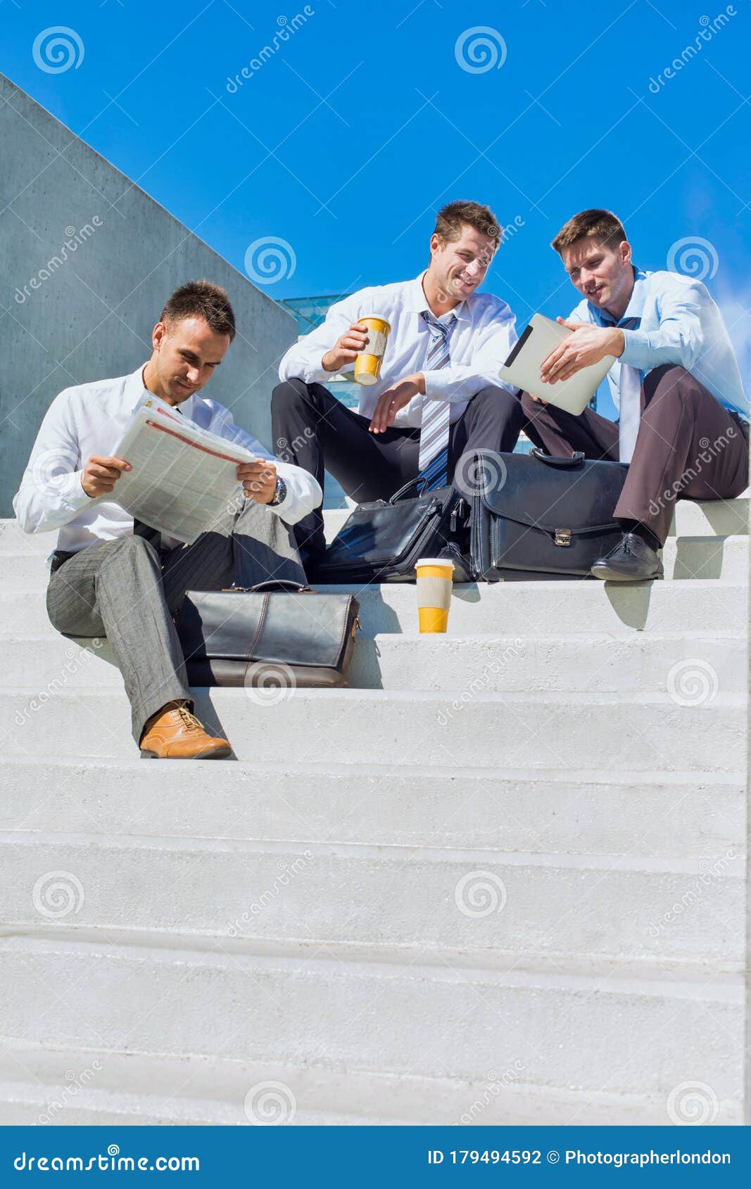 Group Photo of Handsome Businessman Sitting on Stairs while Talking ...