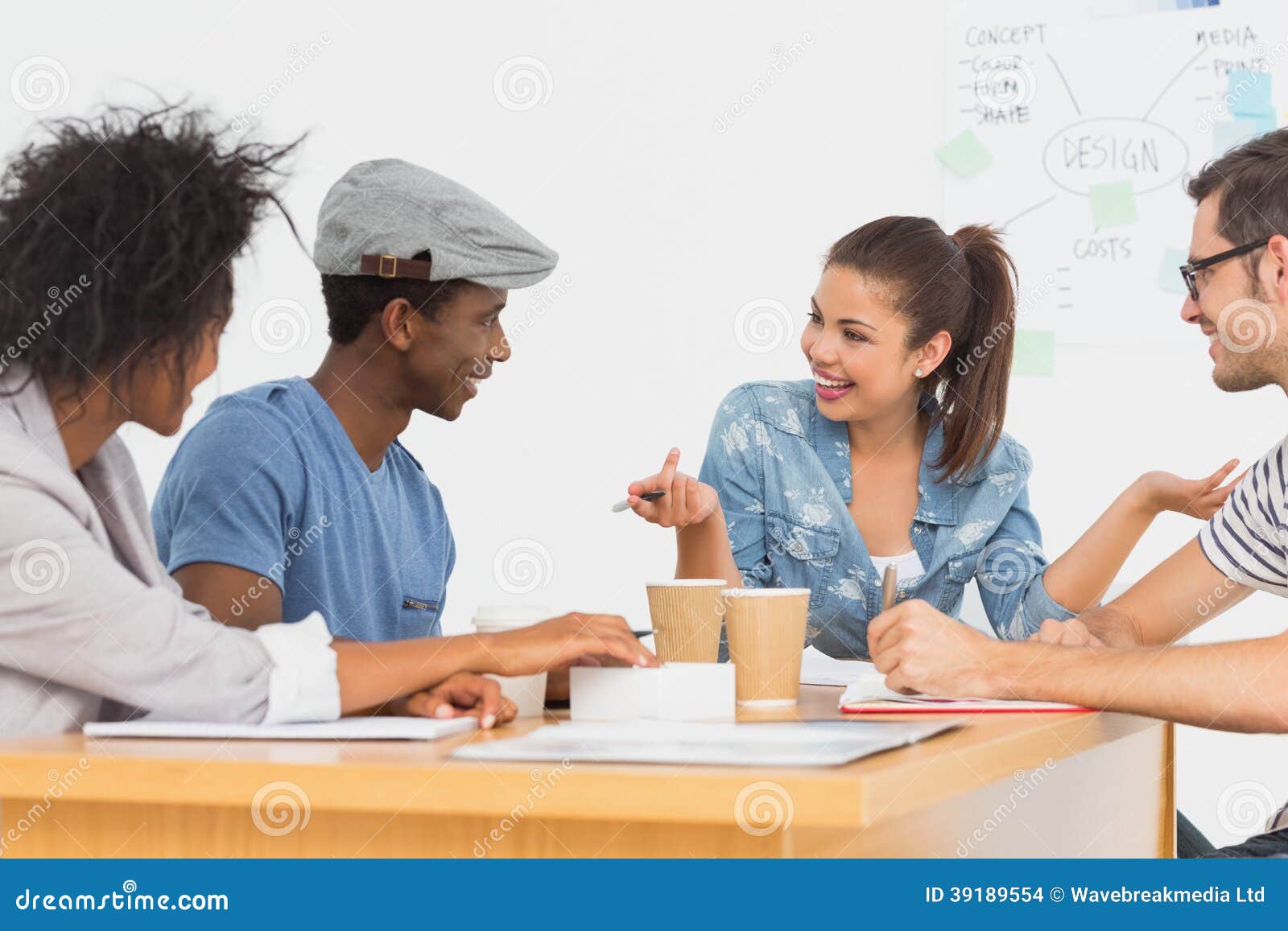Group of Happy Artists in Discussion at Desk Stock Photo - Image of ...