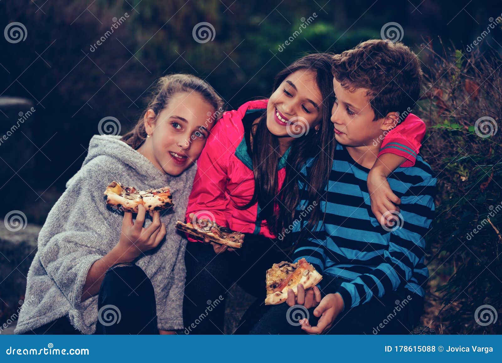 Group of Happy Children Talking and Eating Pizza Outdoors Stock Photo ...