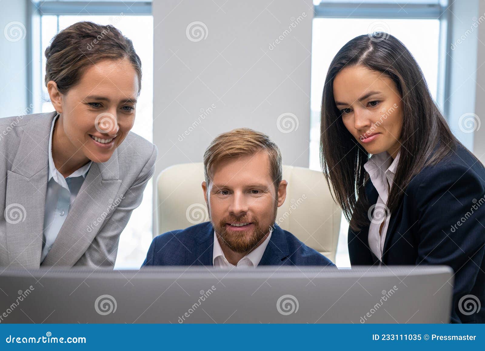 Group of Happy Colleagues Looking at Computer Screen with Smiles Stock ...