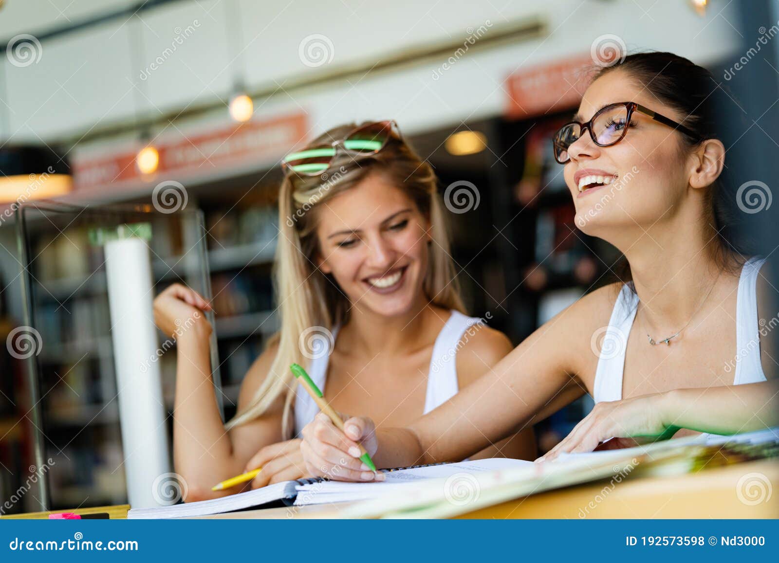 Group of Happy College Students Studying at Campus Library Together ...