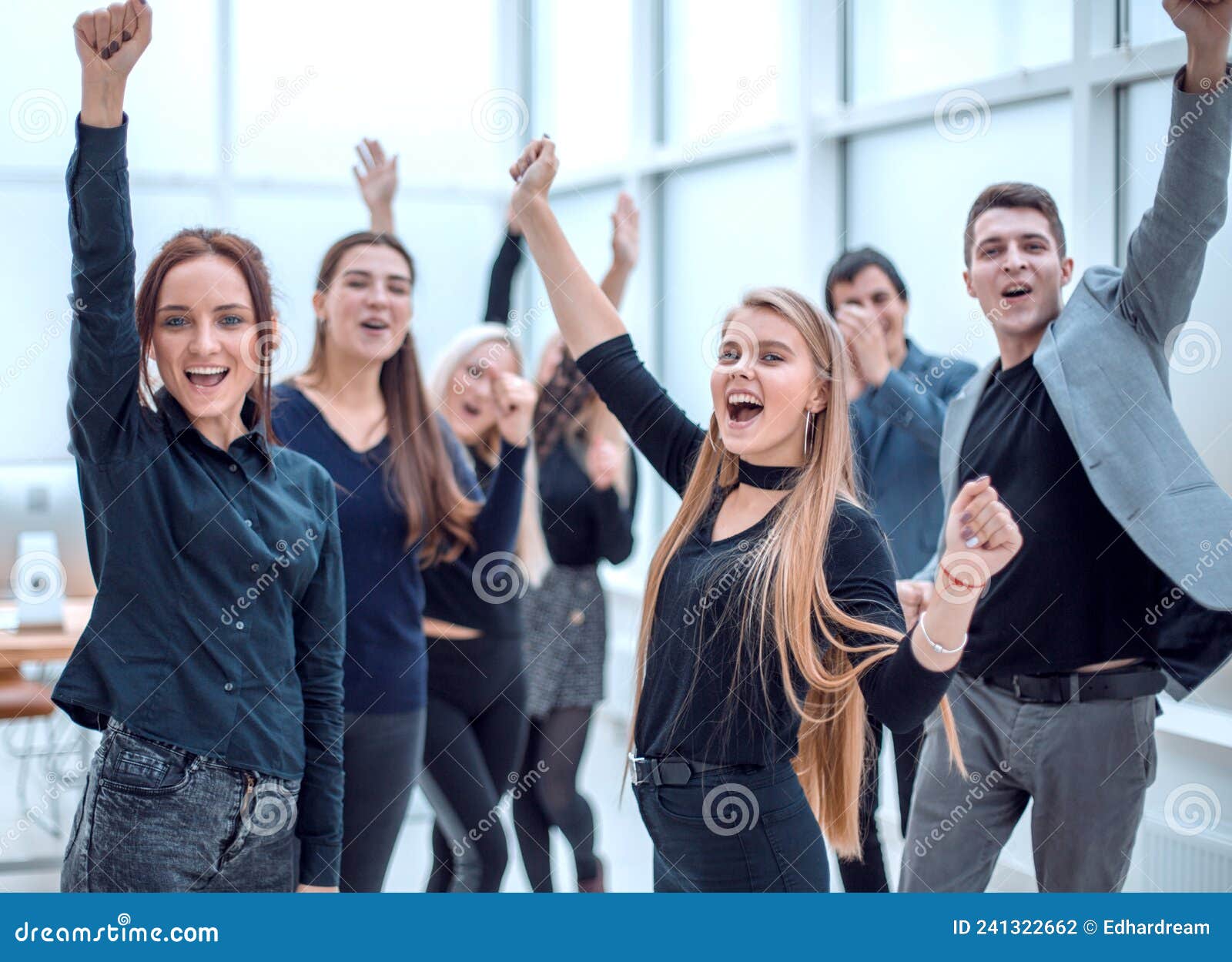 Group of Happy Employees Standing with Their Hands Up Stock Photo ...