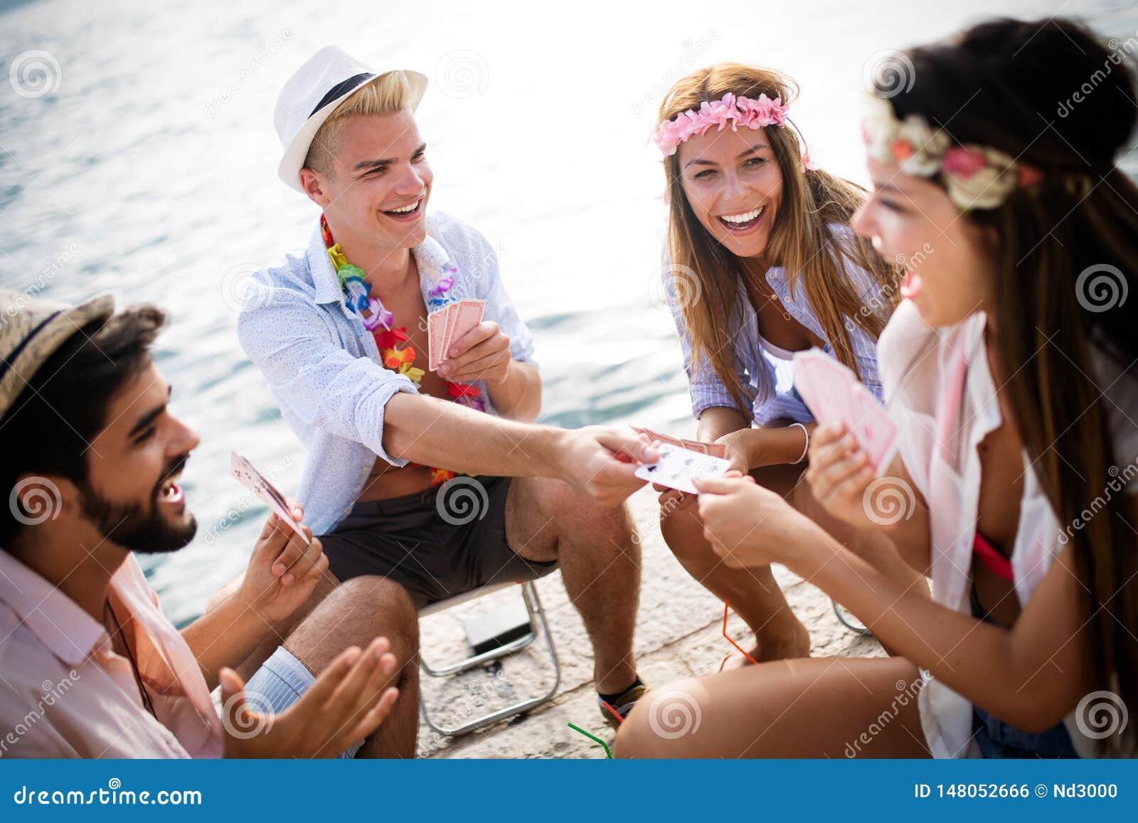 Group of Happy Friends Playing Carts and Having Fun Stock Photo - Image ...