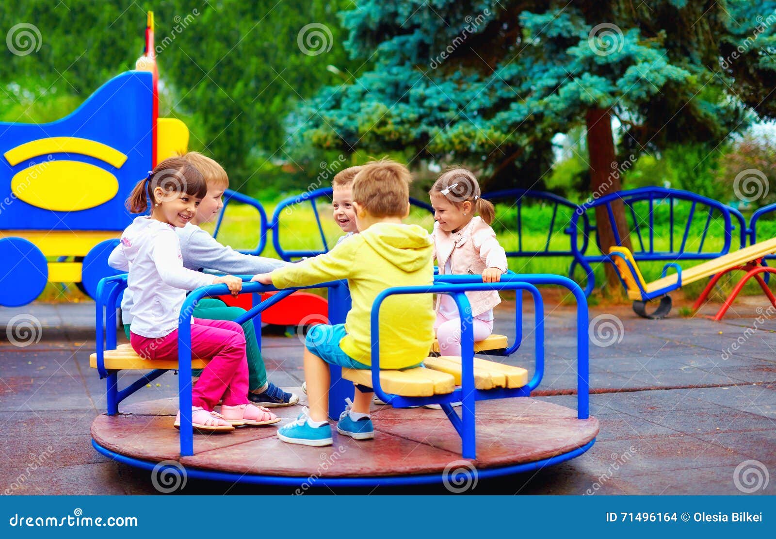 Group of Happy Kids Having Fun on Roundabout at Playground Stock Photo ...
