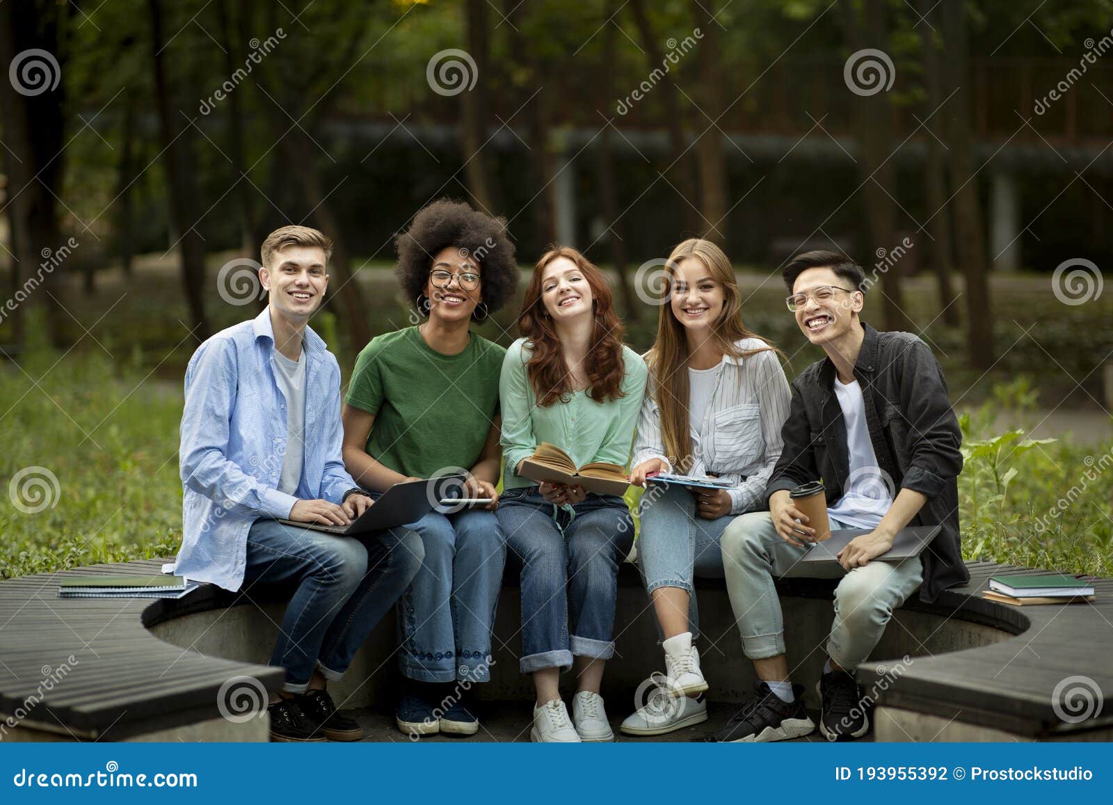Group of Happy Multiracial High-School Students Sitting Together on ...
