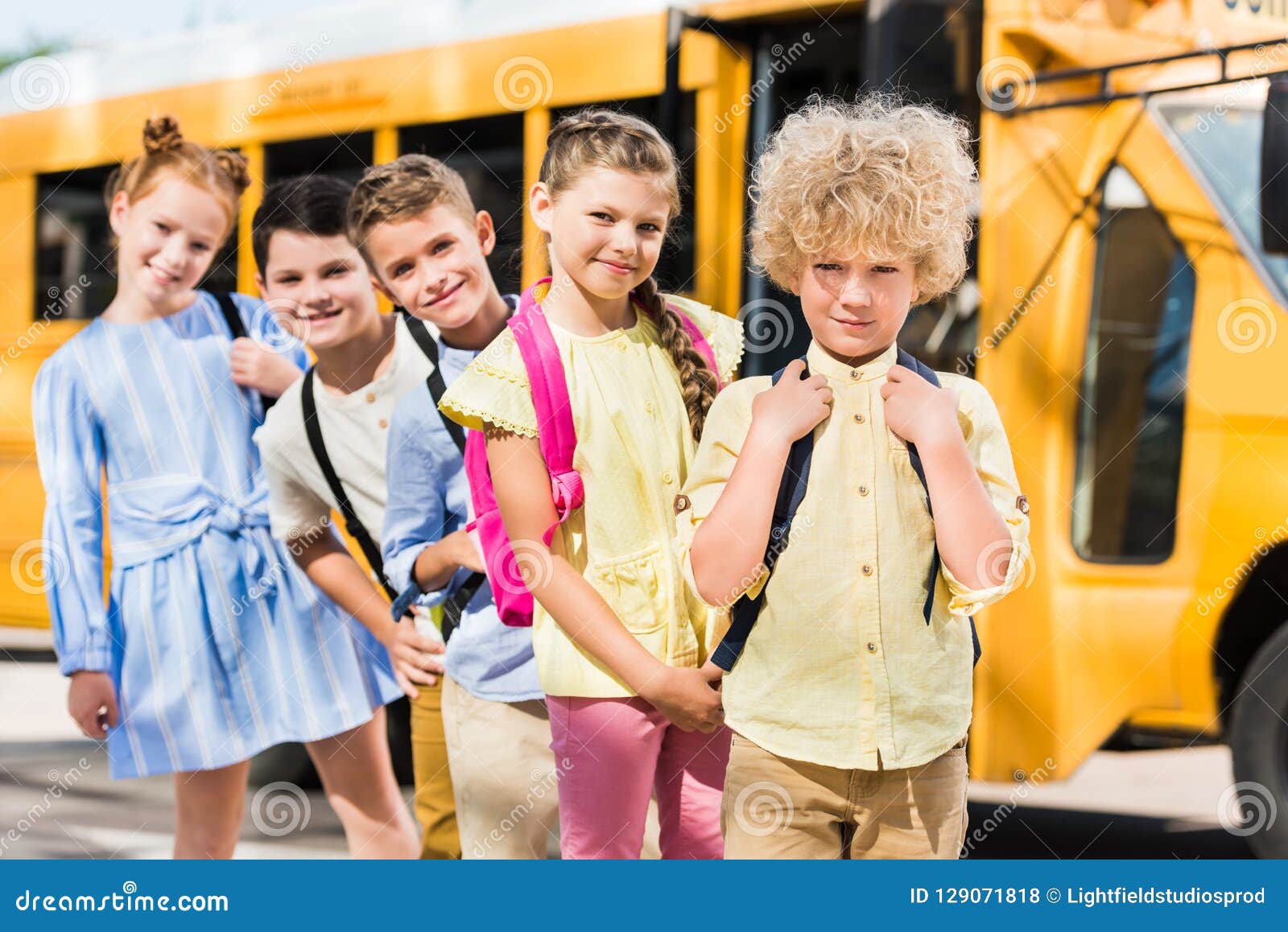 Group of Happy Pupils Looking at Camera while Standing in Row in Front ...