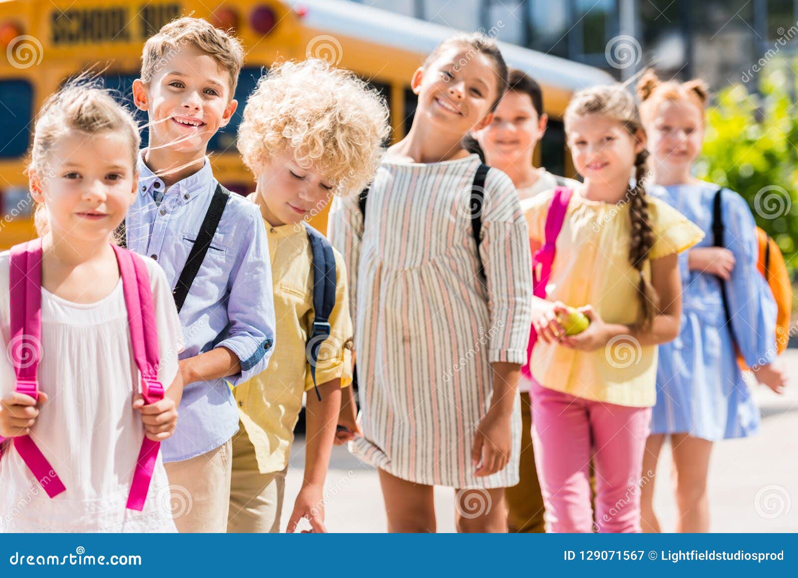 Group of Happy Pupils Standing in Row in Front of Stock Image - Image ...