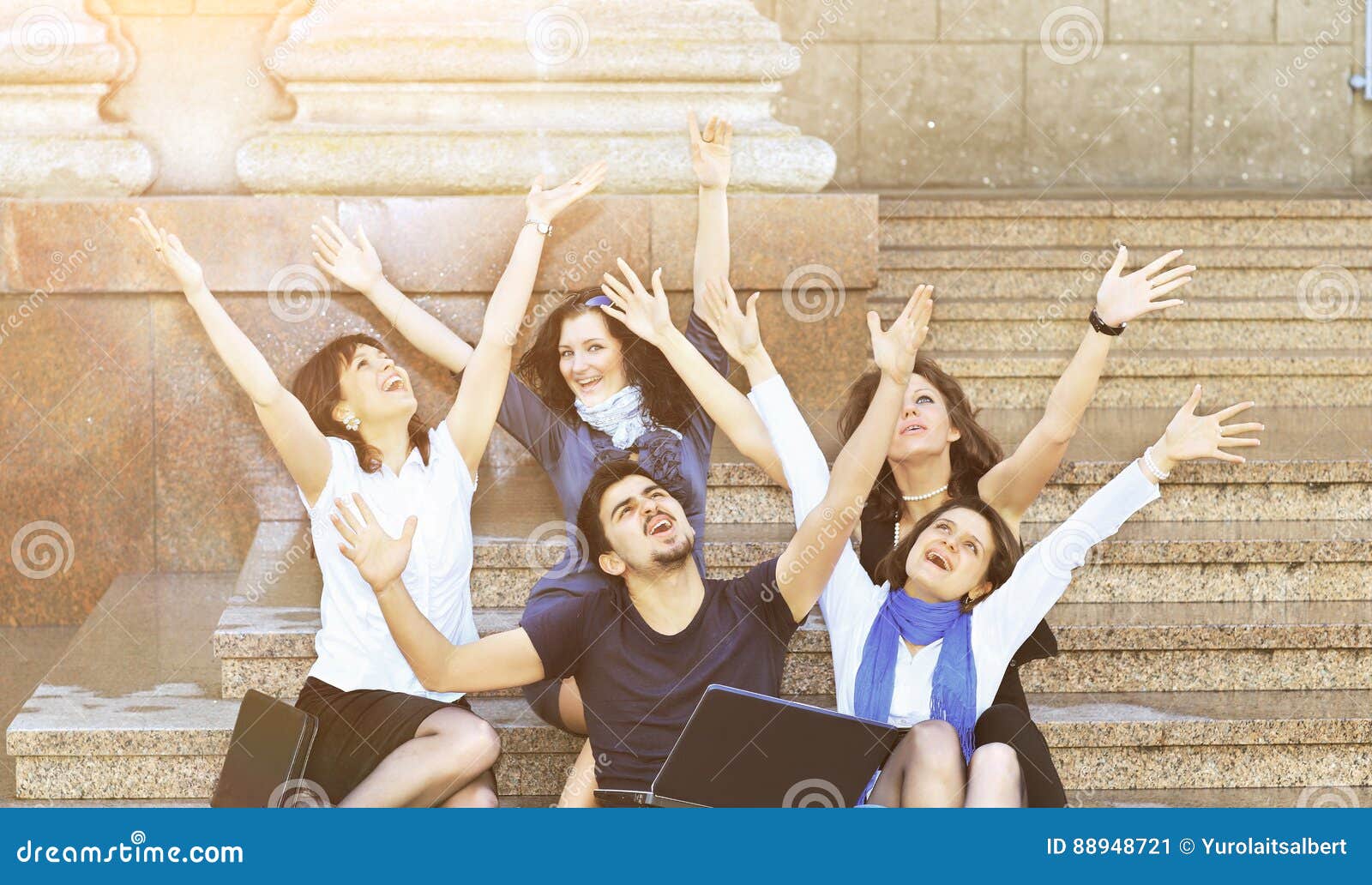 A Group of Happy Students Raise Their Hands Up for Joy in Sunny Weather ...