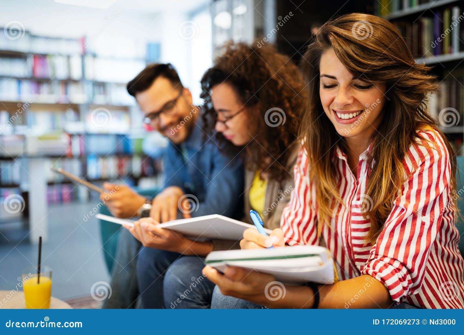 Group of Happy Students Reading Books and Preparing To Exam in Library ...