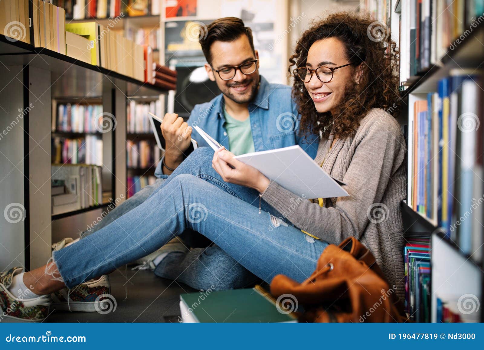 Group of Happy Students Reading Books and Preparing To Exam in Library ...