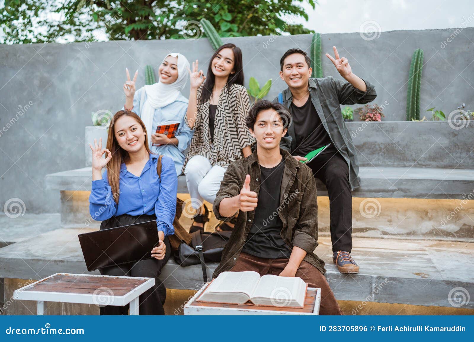Group of Happy Students Smiling with Some Hand Gestures while Sitting ...