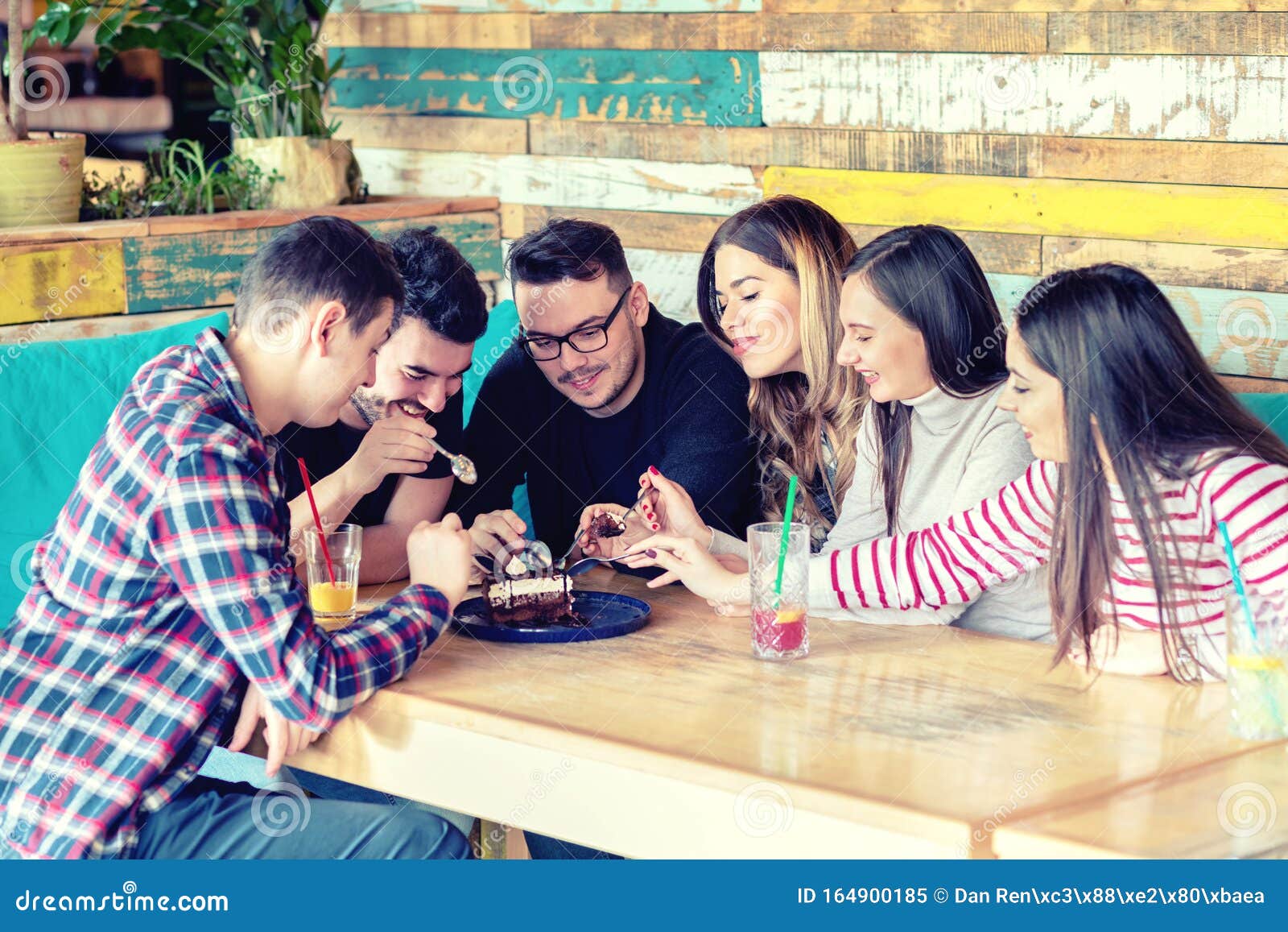 Group of Happy Young Friends Sharing and Eating Dessert Cake at Cafe ...