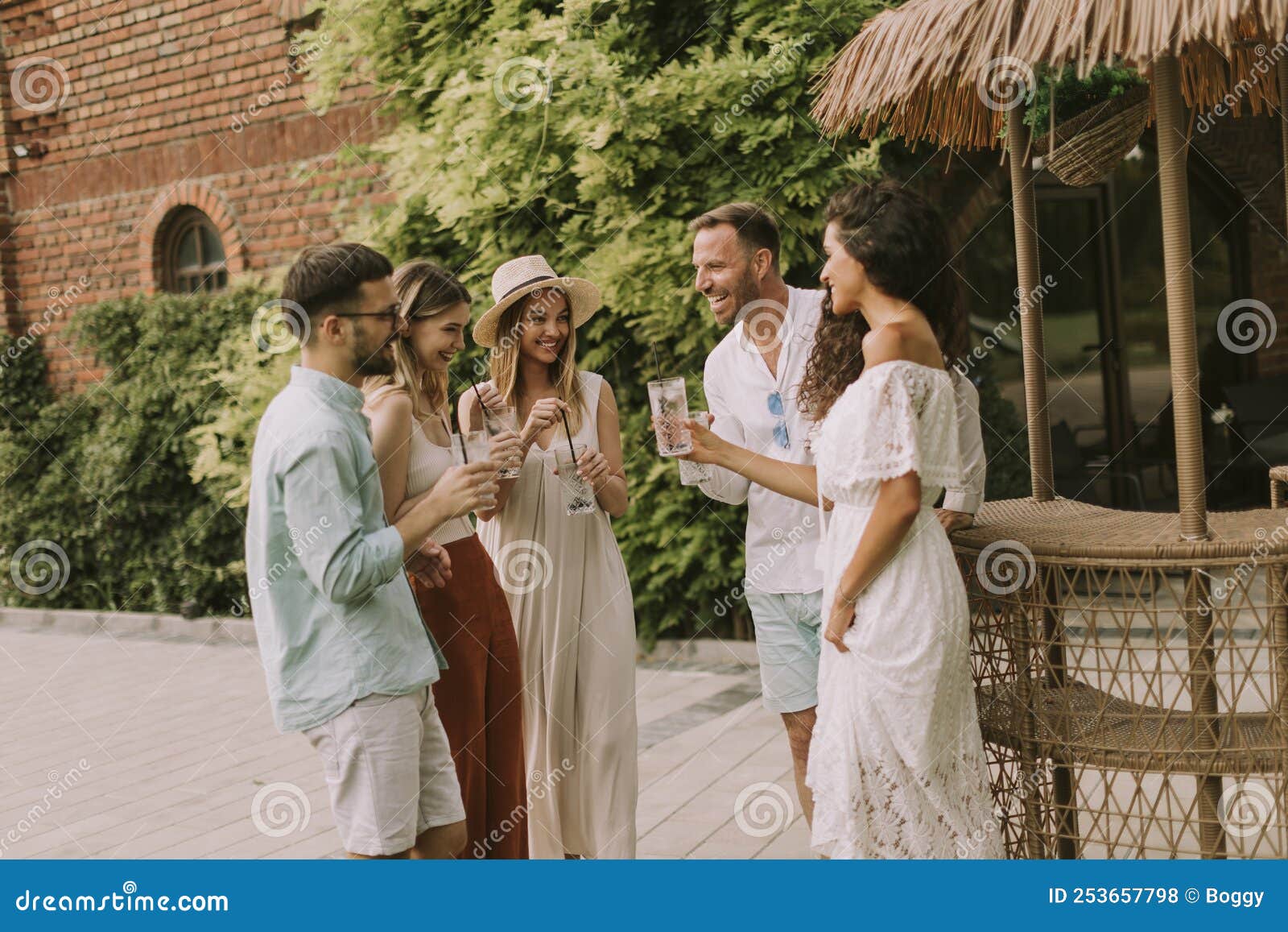 Group of Young People Cheering and Having Fun Outdoors with Drinks ...