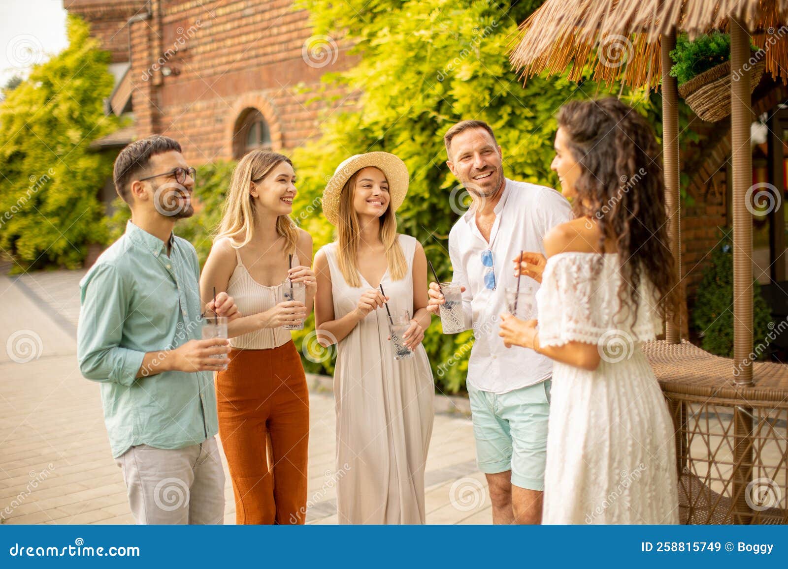 Group of Young People Cheering and Having Fun Outdoors with Drinks ...