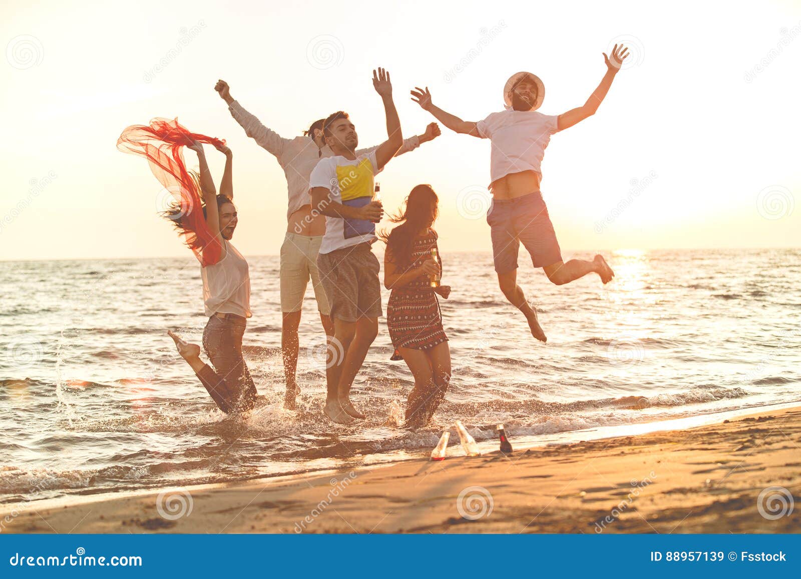 Group of Happy Young People Dancing at the Beach on Beautiful Summer ...