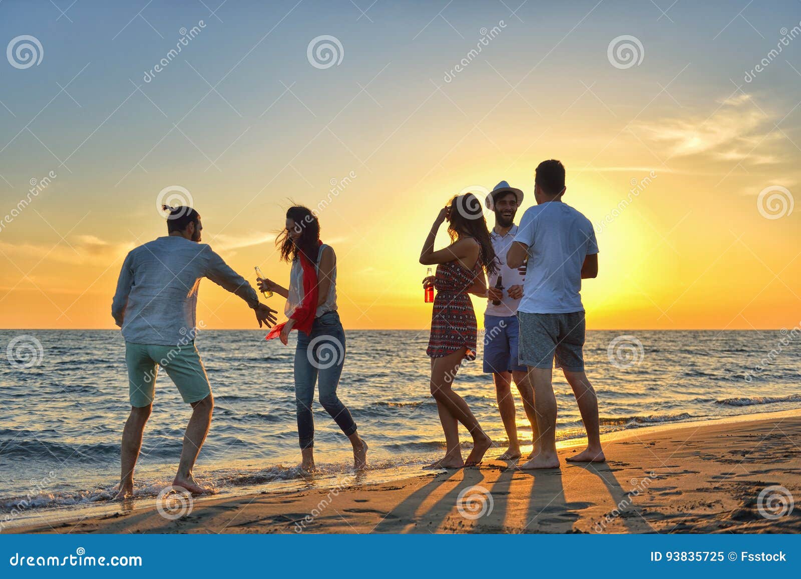 Group of Happy Young People Dancing at the Beach on Beautiful Summer ...