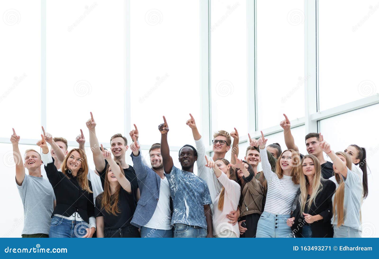 Group of Happy Young People Pointing Upwards Stock Image - Image of ...
