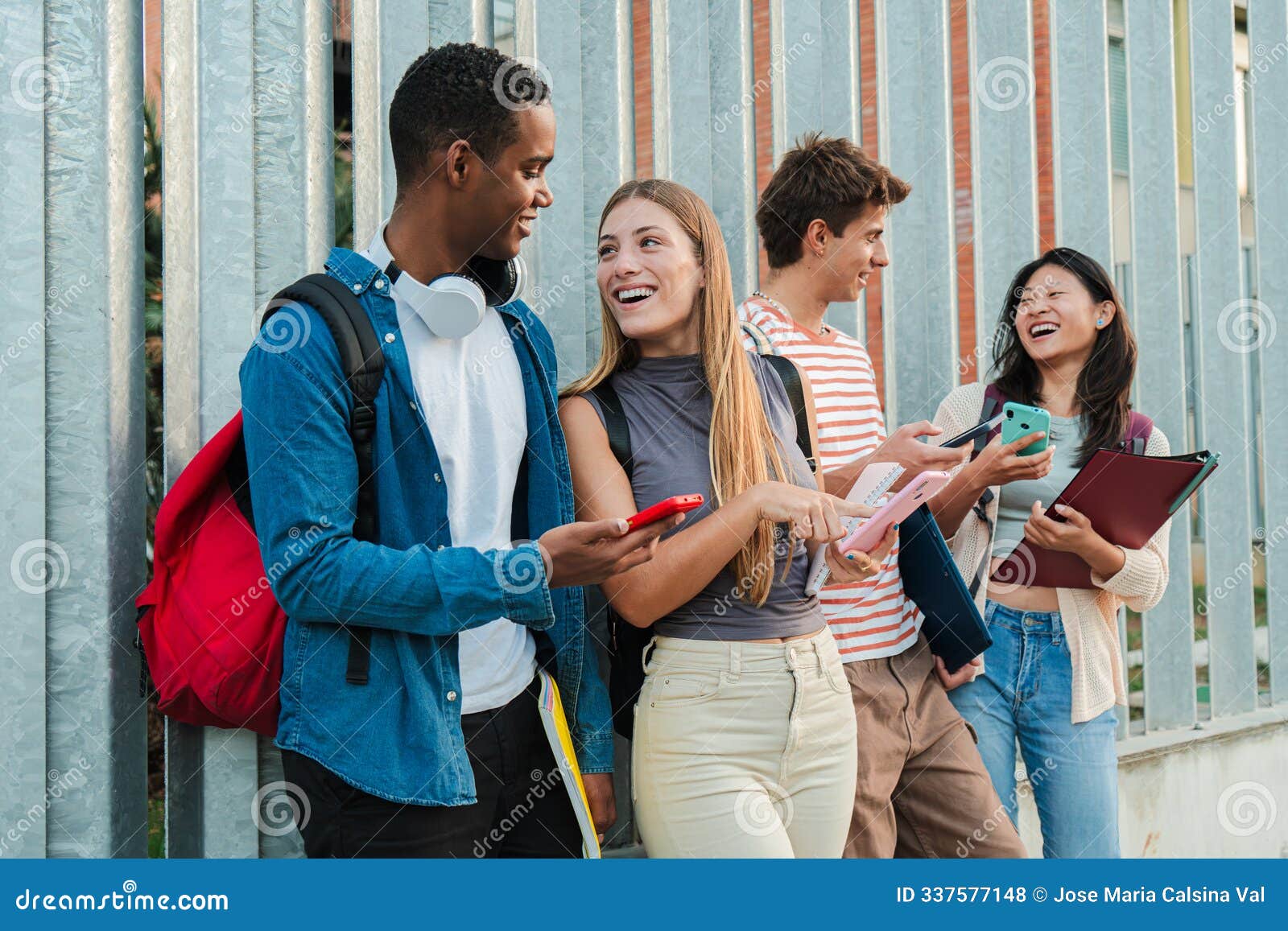 Group of Happy Young Students Socializing on University Campus ...