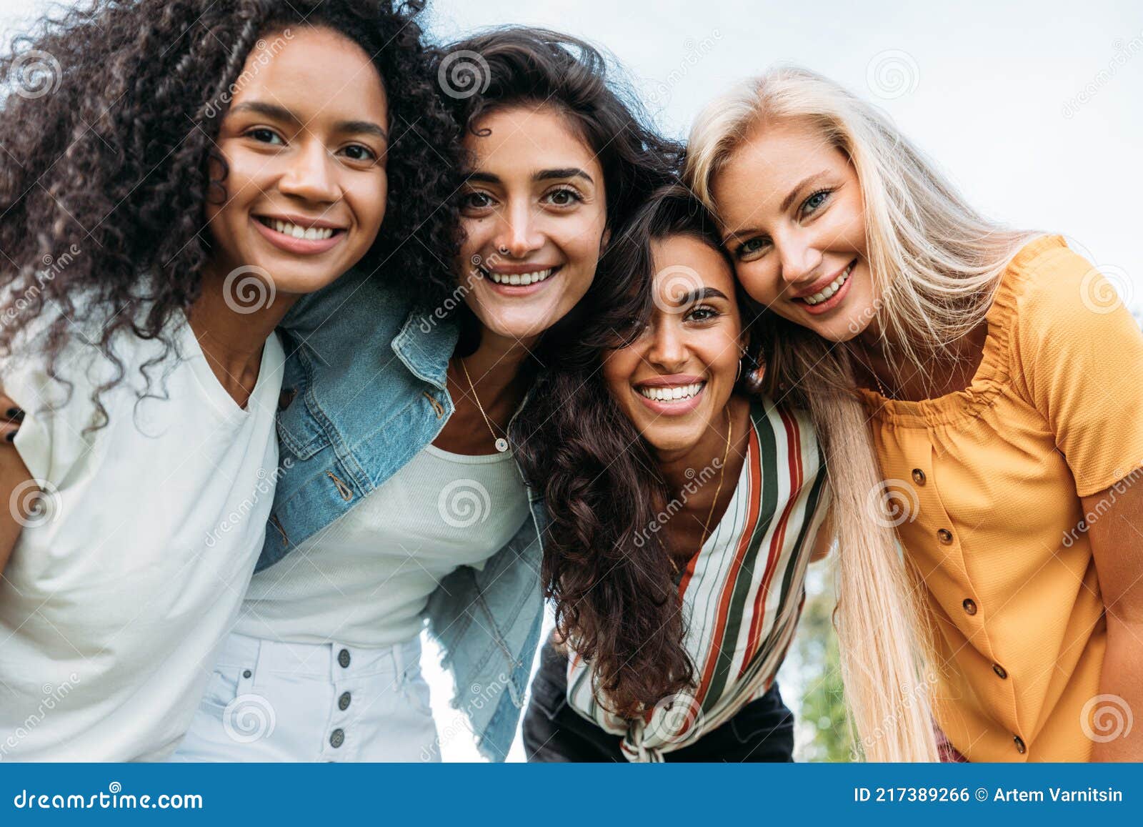 Group of Happy Young Women Standing Together and Looking at Camera ... Group of Happy Young Women Standing Together and Looking at Camera ...