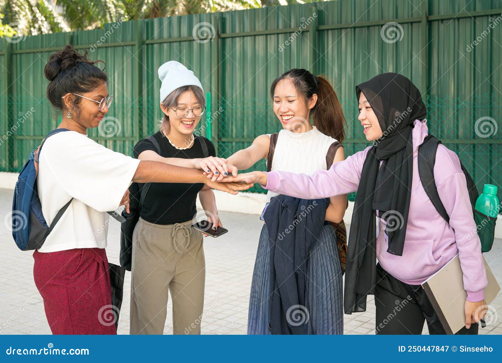 Group of Happy Young Women Students Putting and Stacking Their Hands ...