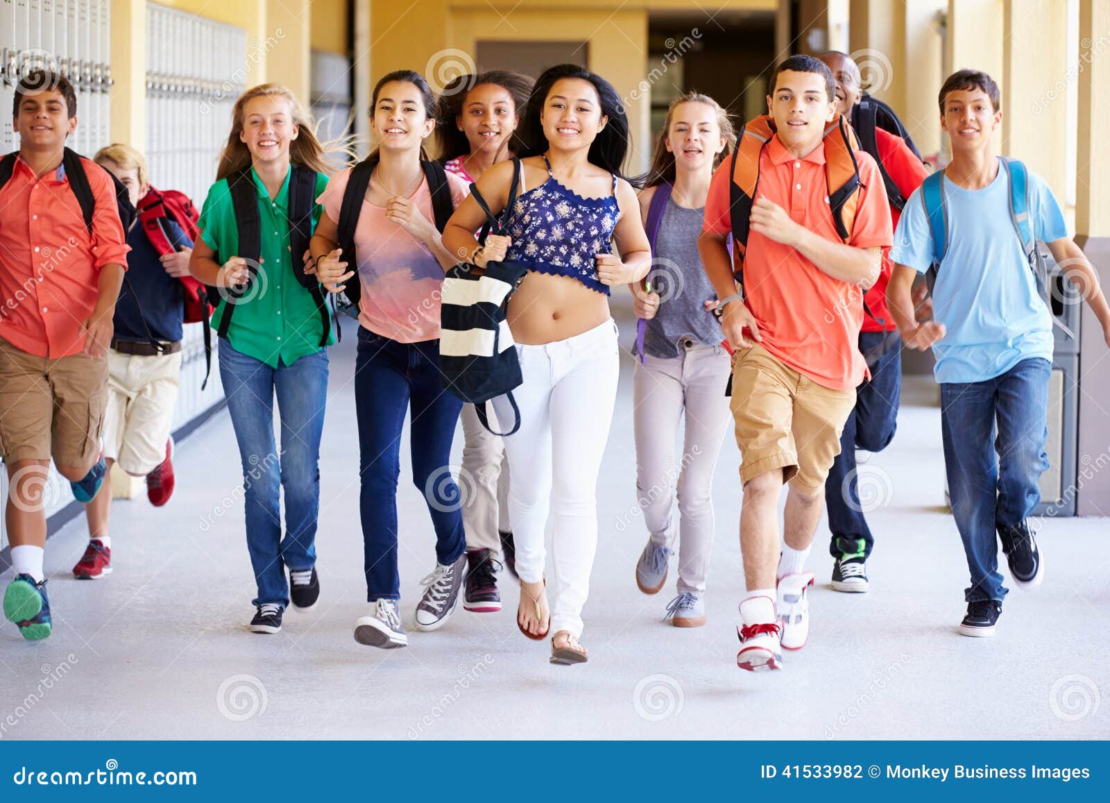 Group of High School Students Running Along Corridor Stock Photo ...
