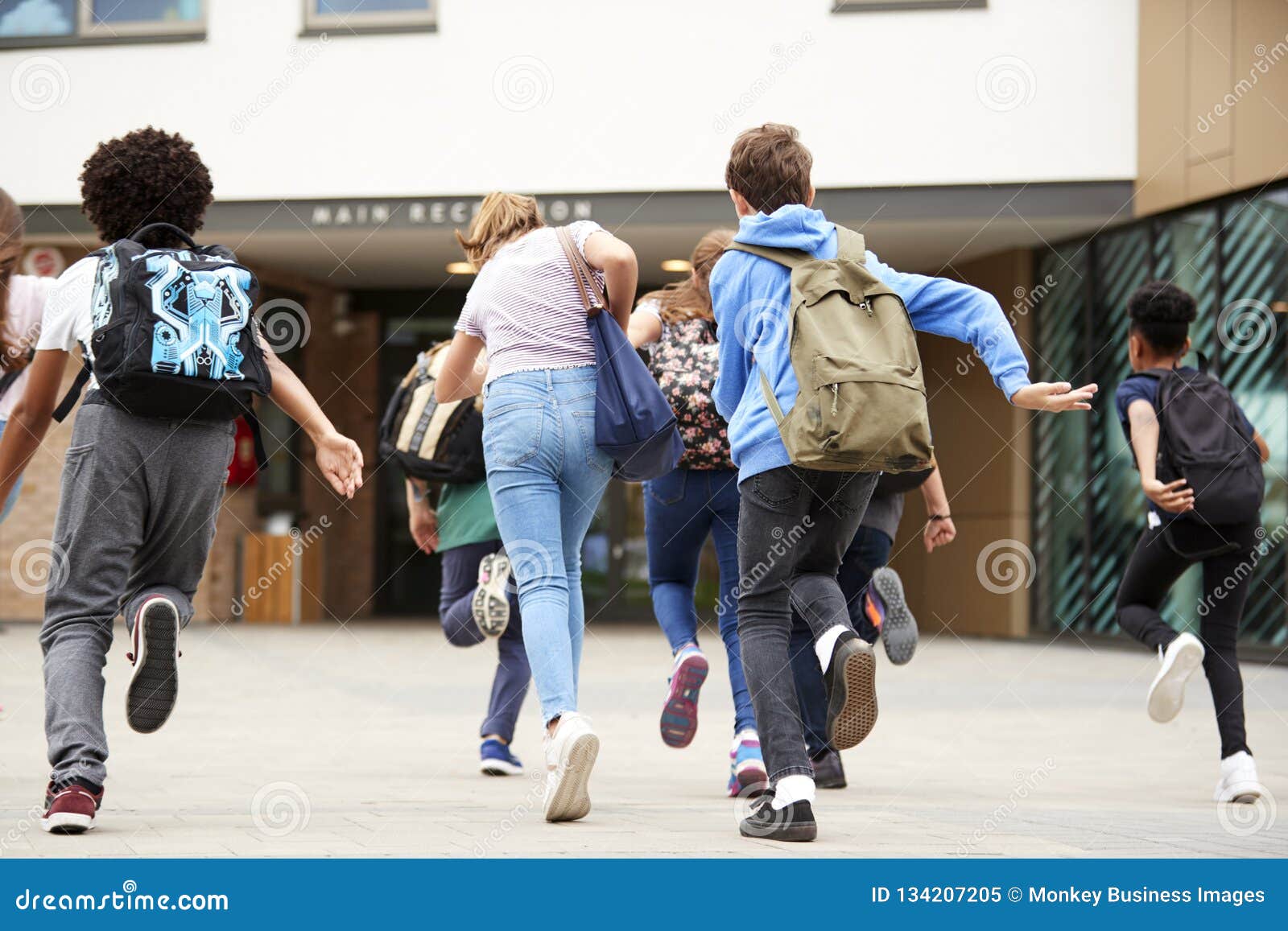 Group of High School Students Running into School Building at Beginning ...