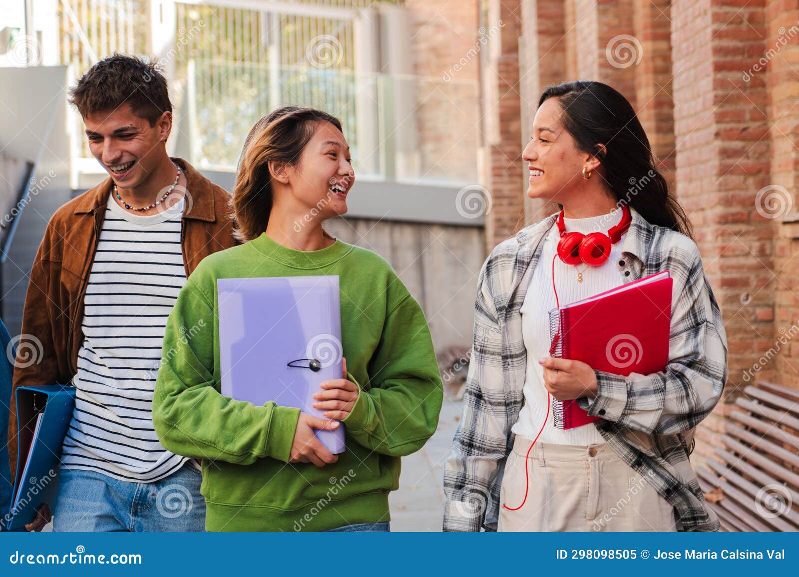 Group of Highschool Classmates Going To Class Carrying Their Folders ...