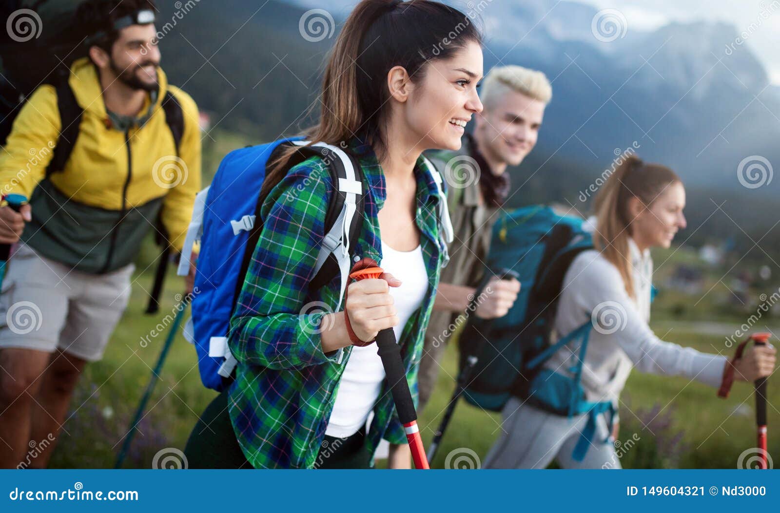 Group of Hikers with Backpacks and Sticks Walking on Mountain. Friends ...