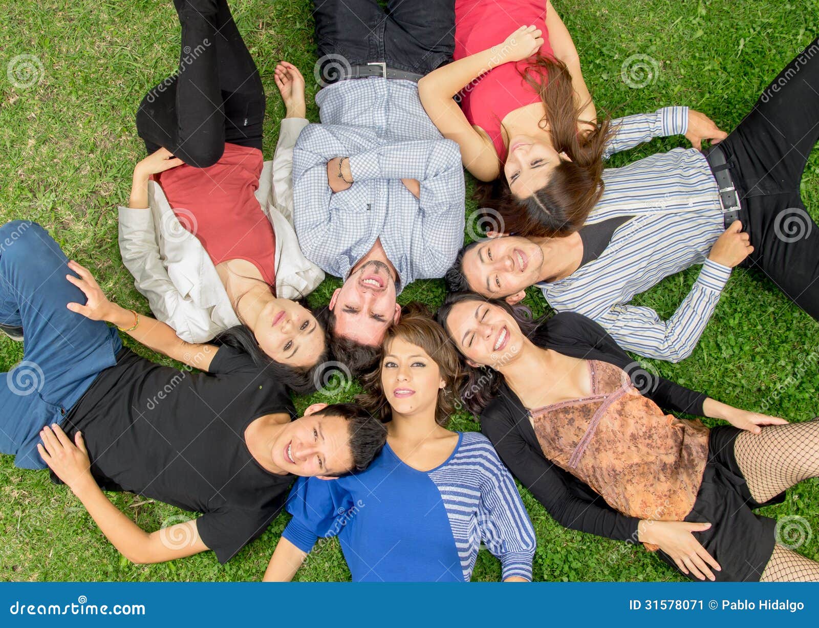 Group of Hispanic Friends Laying Down in Park Stock Image - Image of ...