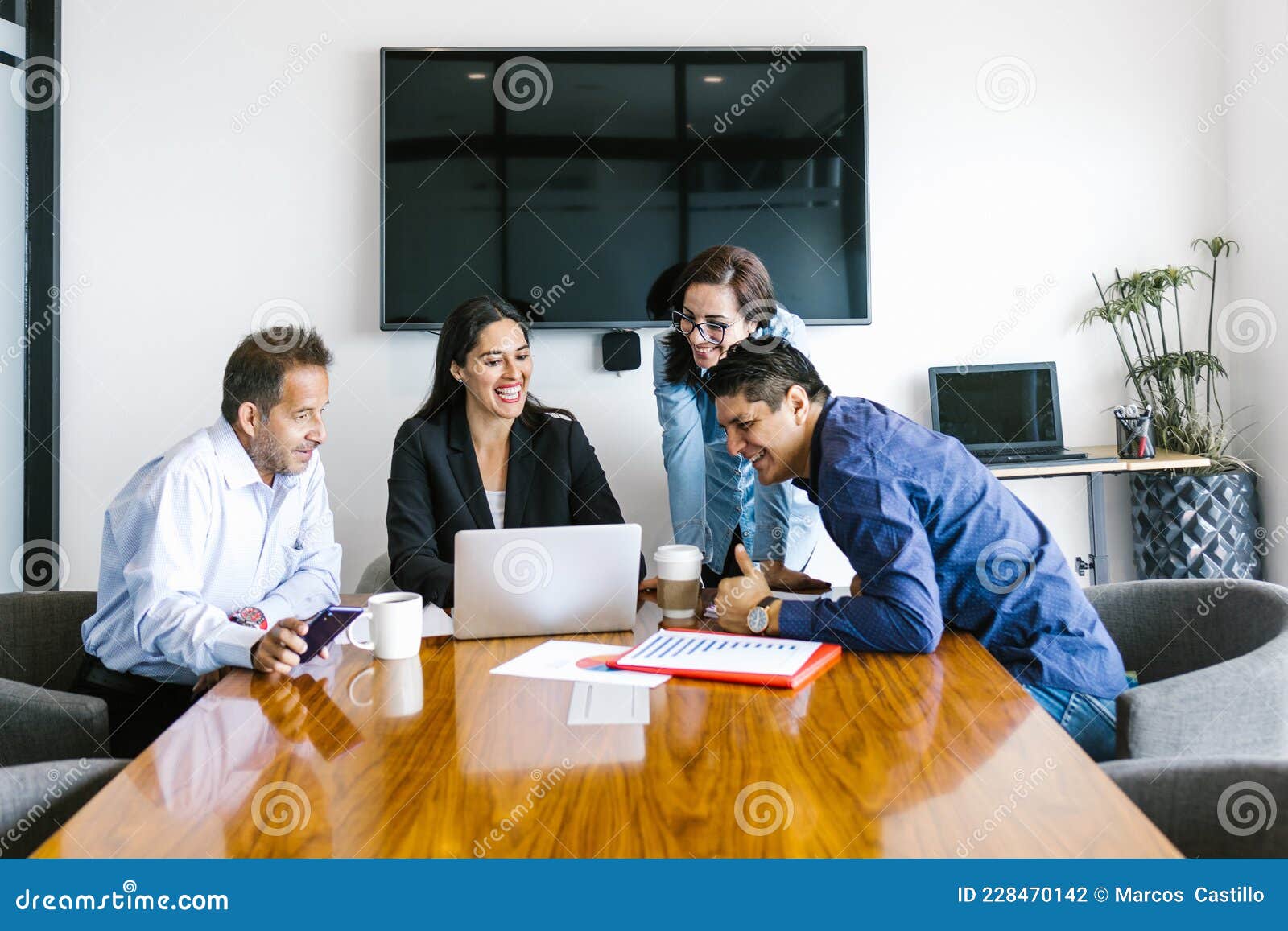 Group of Hispanic People Doing Teamwork in Office Using Digital Devices ...
