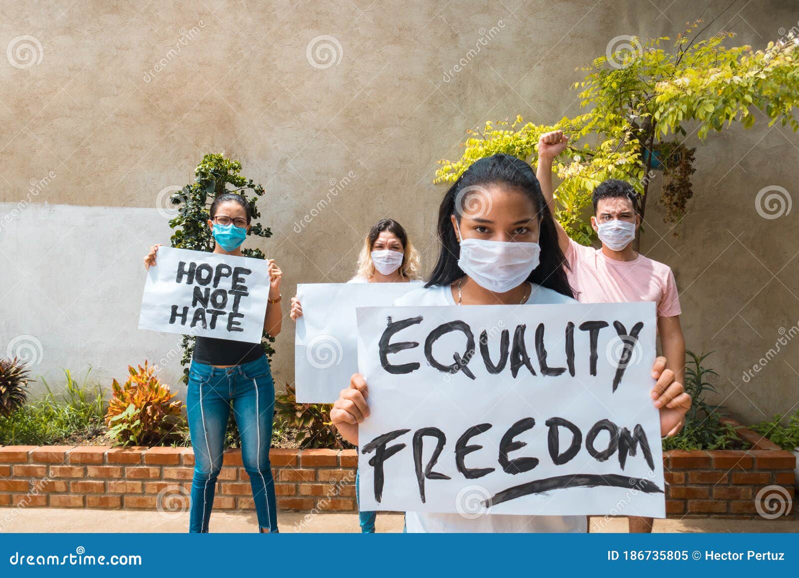 A Group of Hispanic Youths at a Protest Holding Signs Stock Image ...