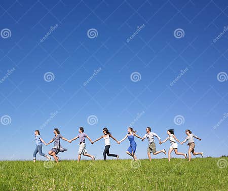 Group Holding Hands Running Stock Image - Image of playful, adult: 11009129