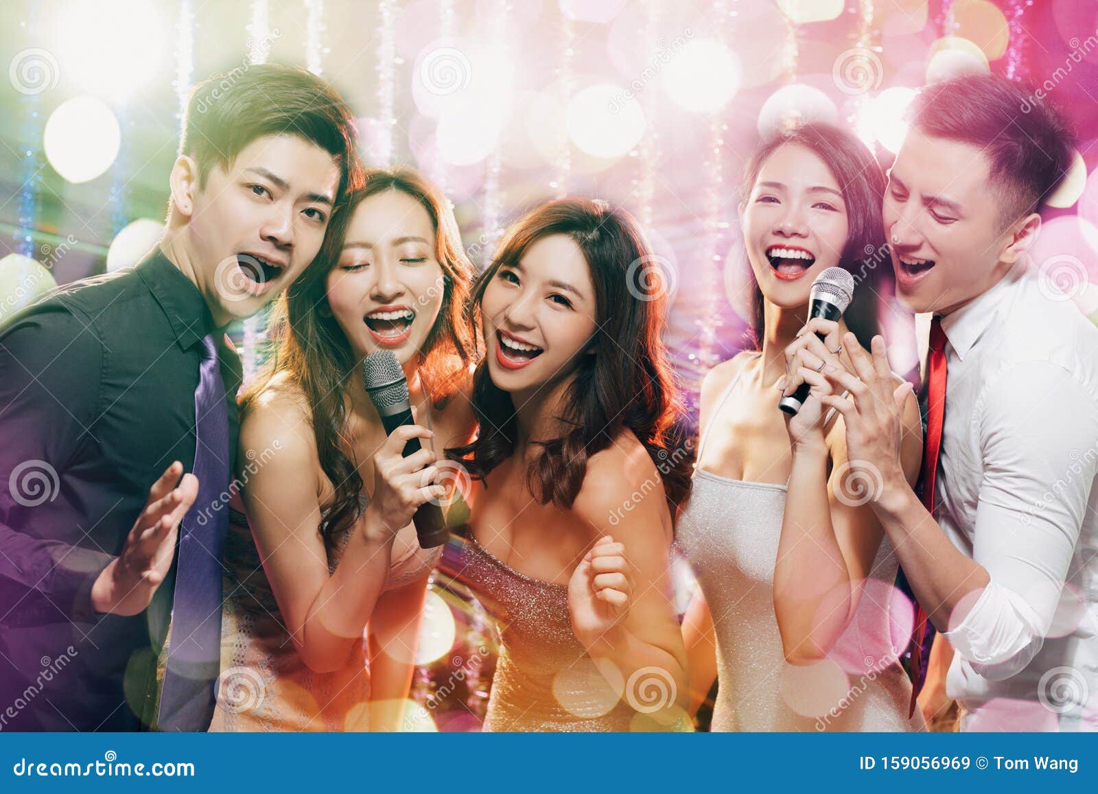 Group Holding Microphone and Singing at Karaoke Stock Image - Image of ...