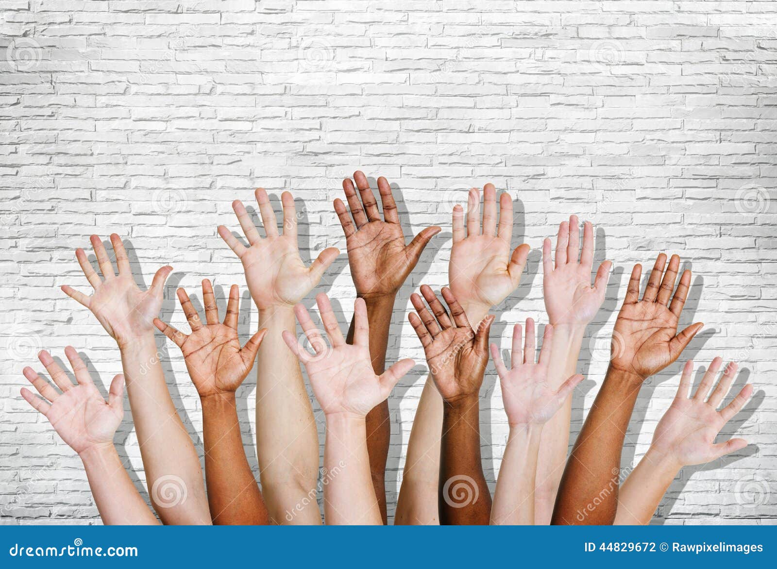Group of Human Arms Raised with Brick Wall Stock Photo - Image of ...